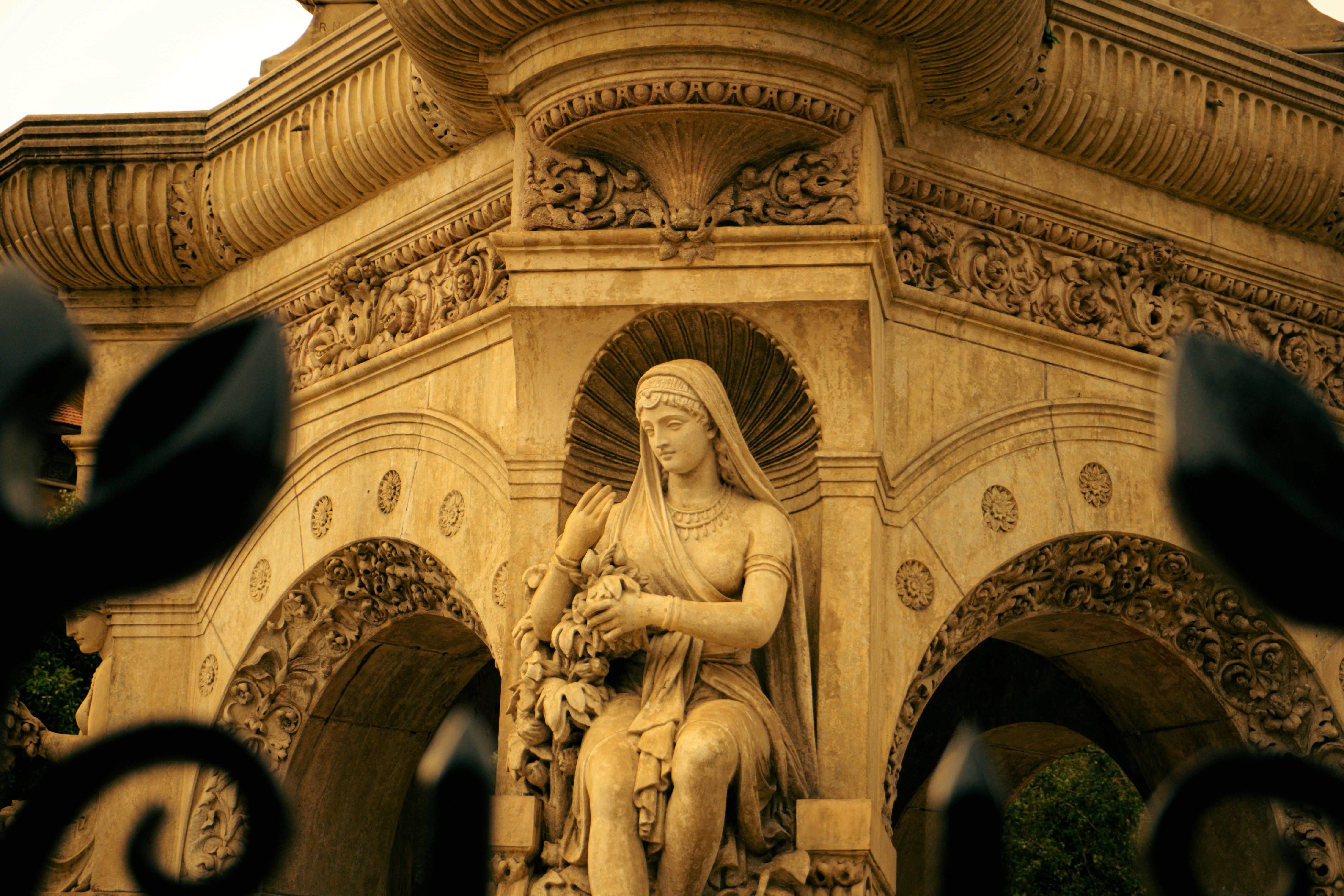 Sculpted Grace Beneath Arching Carvings