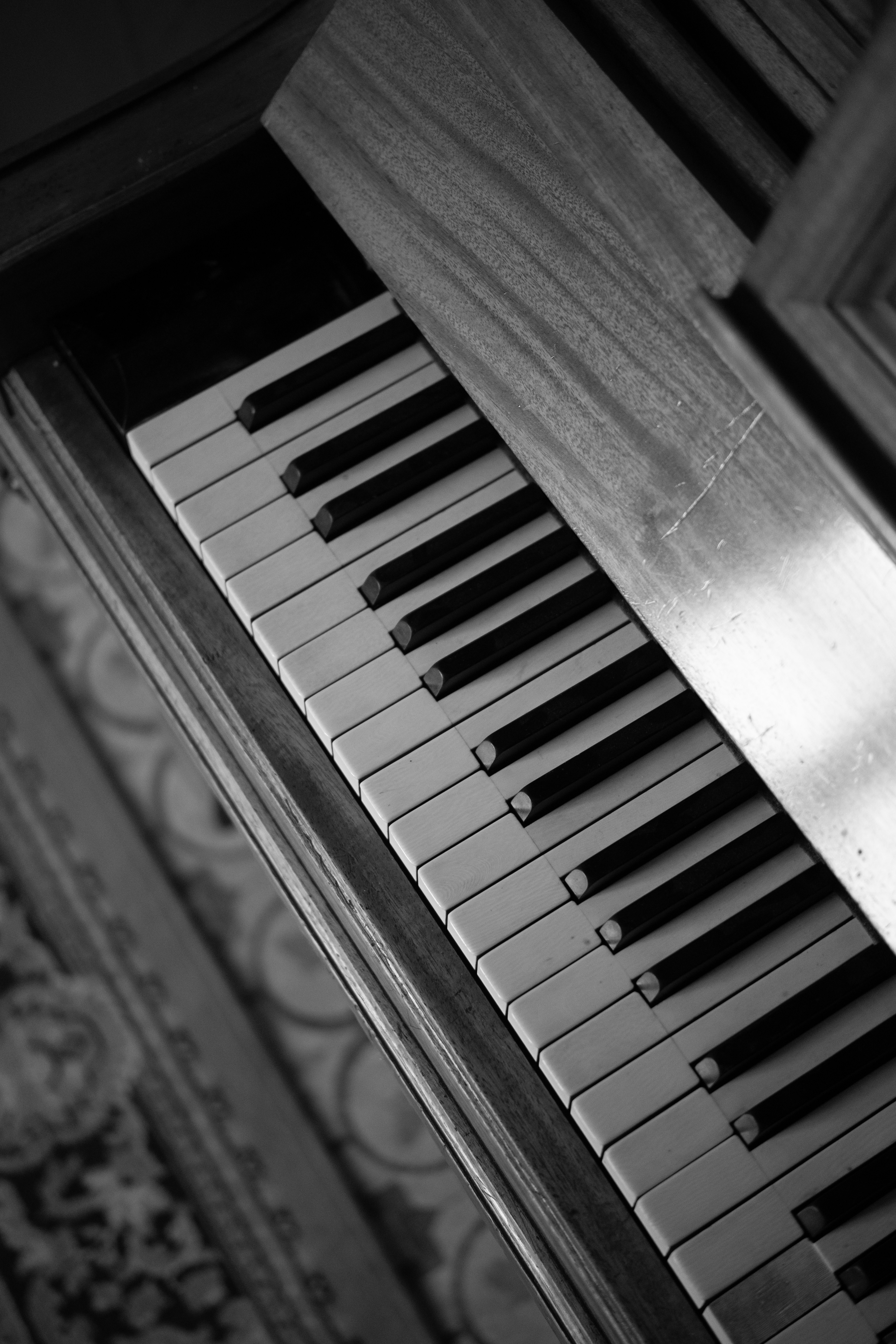 Close-up of vintage piano keys in black and white.