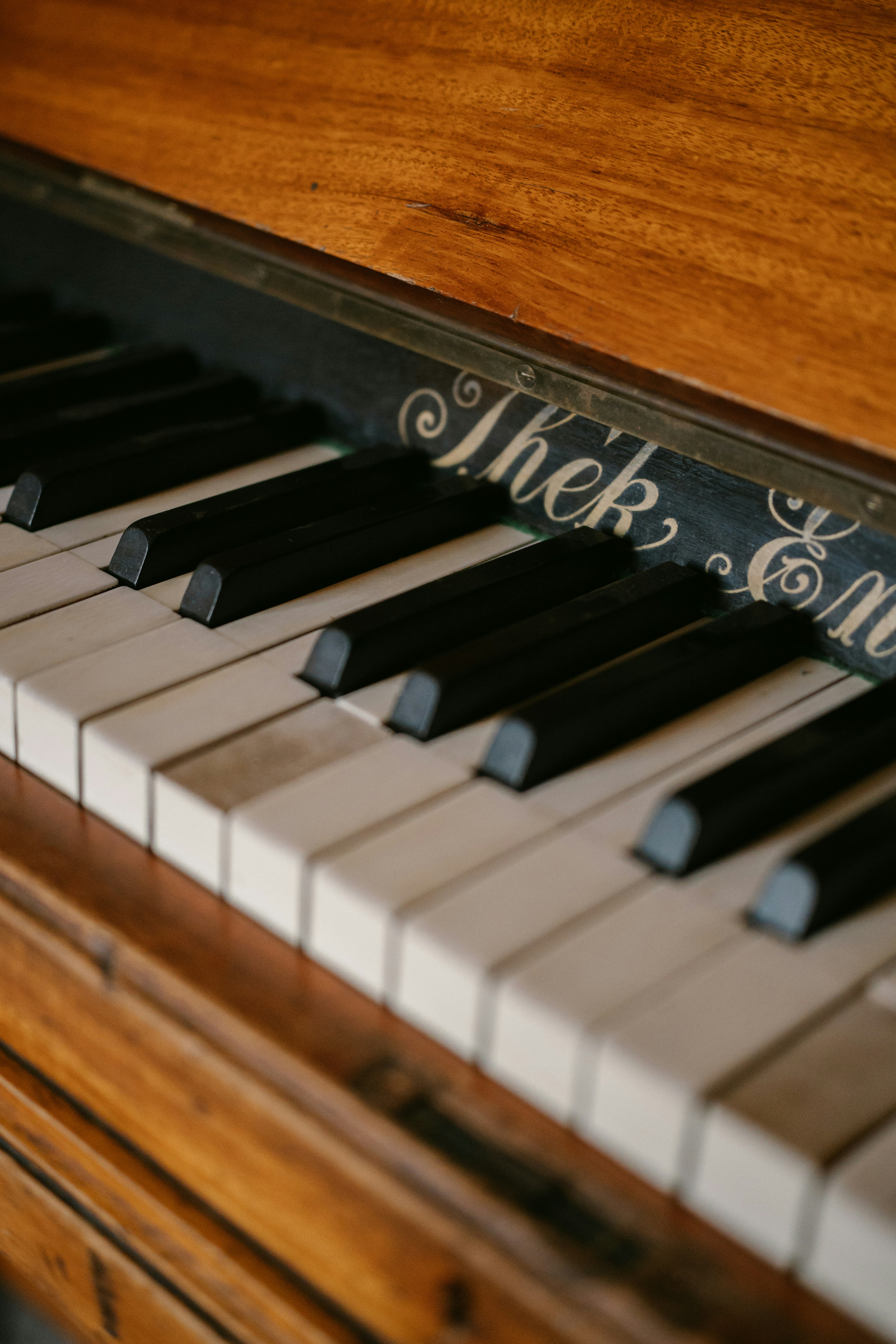 Whispers of Wood and Keys: Close-Up on a Timeworn Piano