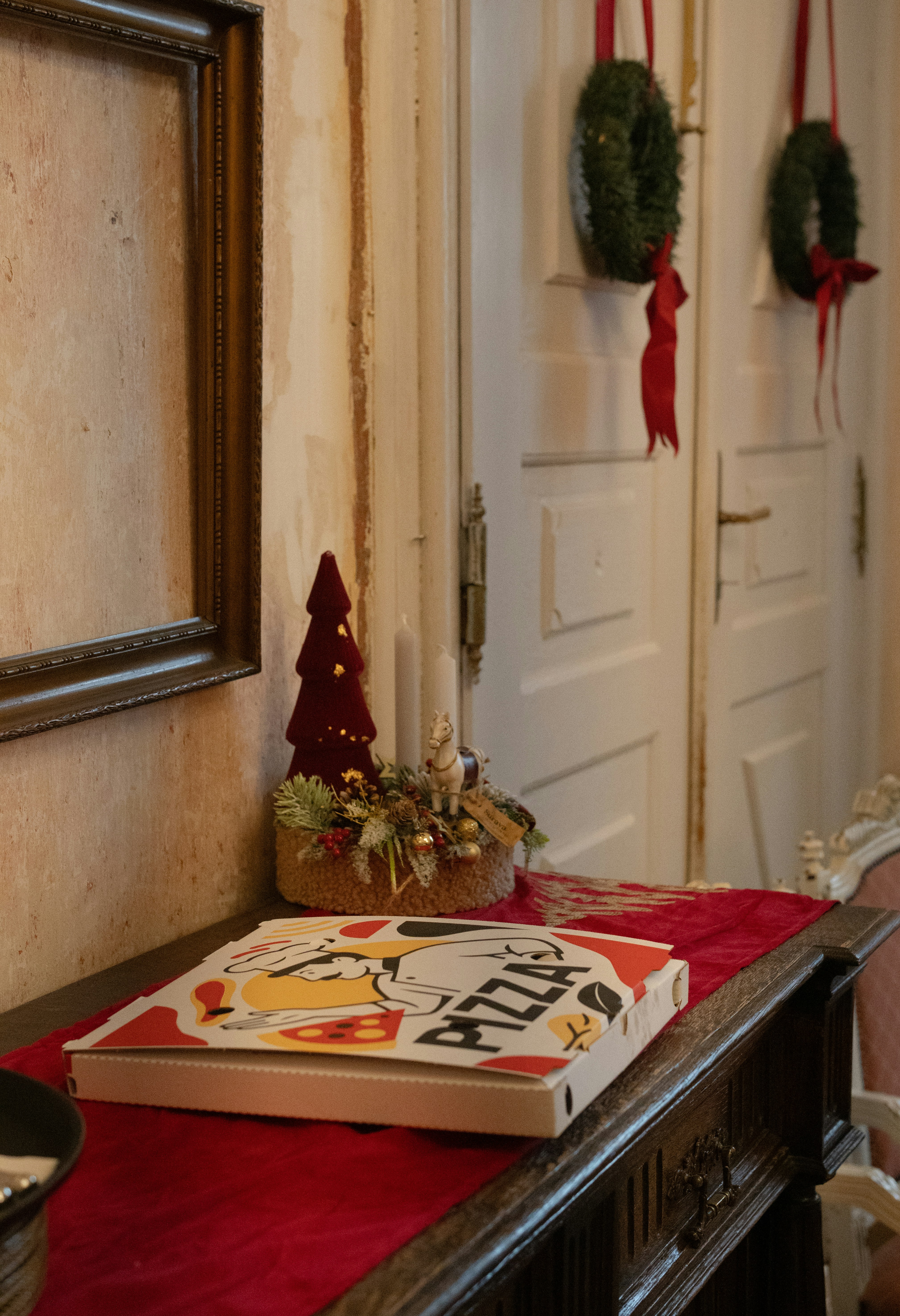 Holiday Hallway: A Cozy Pizza Box Beneath Christmas Cheer