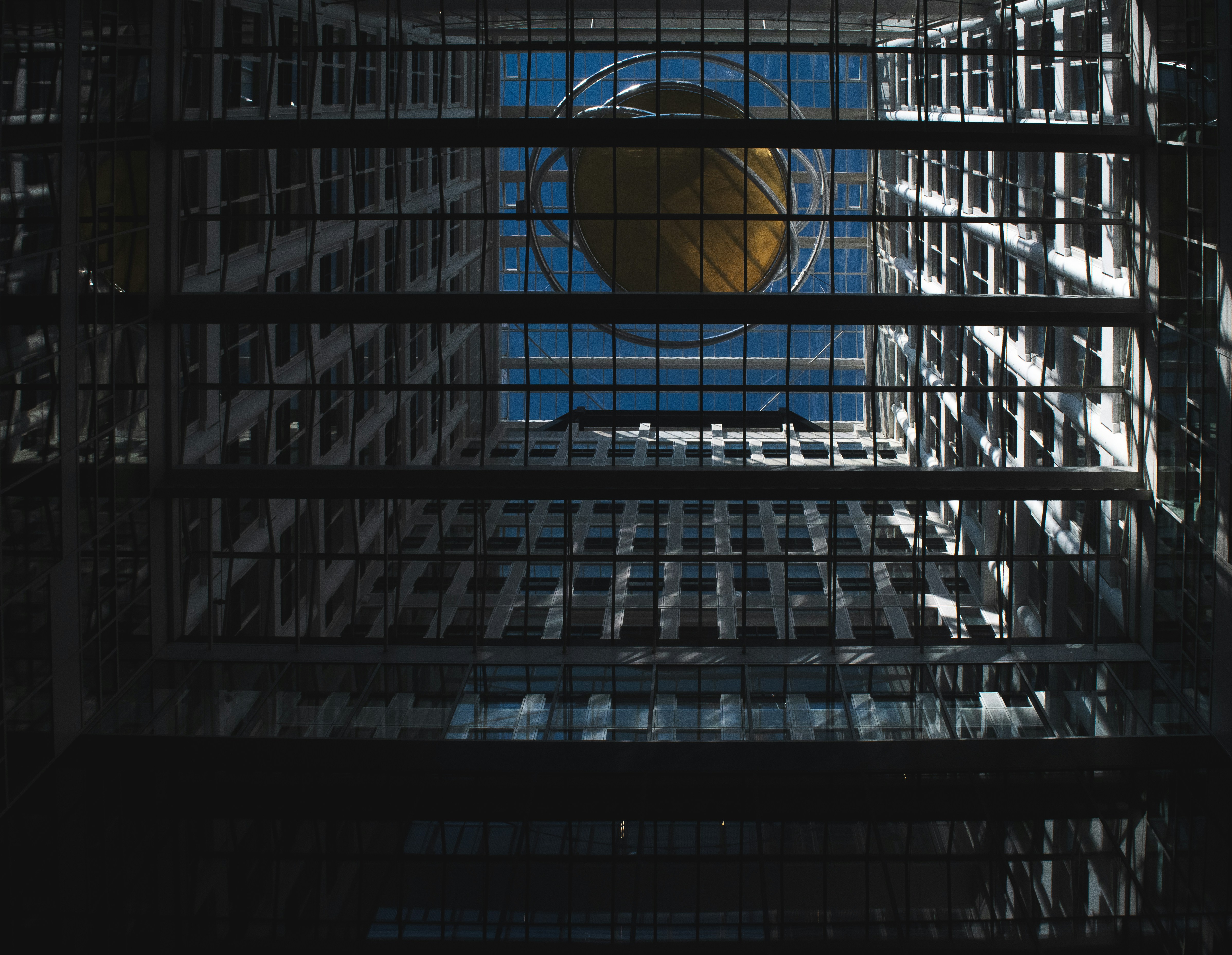 Caged Geometry: A Skyward Slice Through Elevator Grates