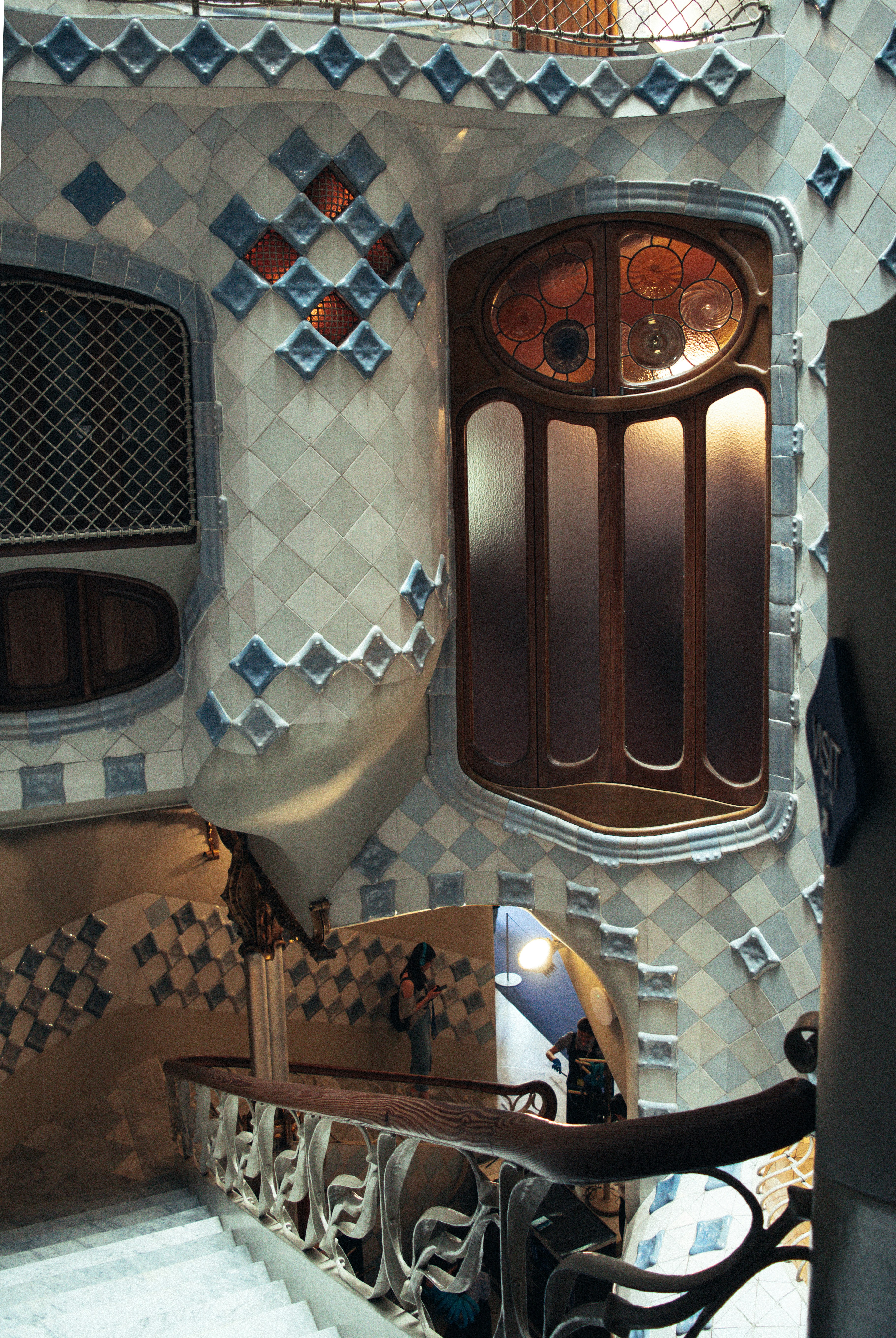 Architectural Whimsy: White Mosaic Facade and Curved Doorway