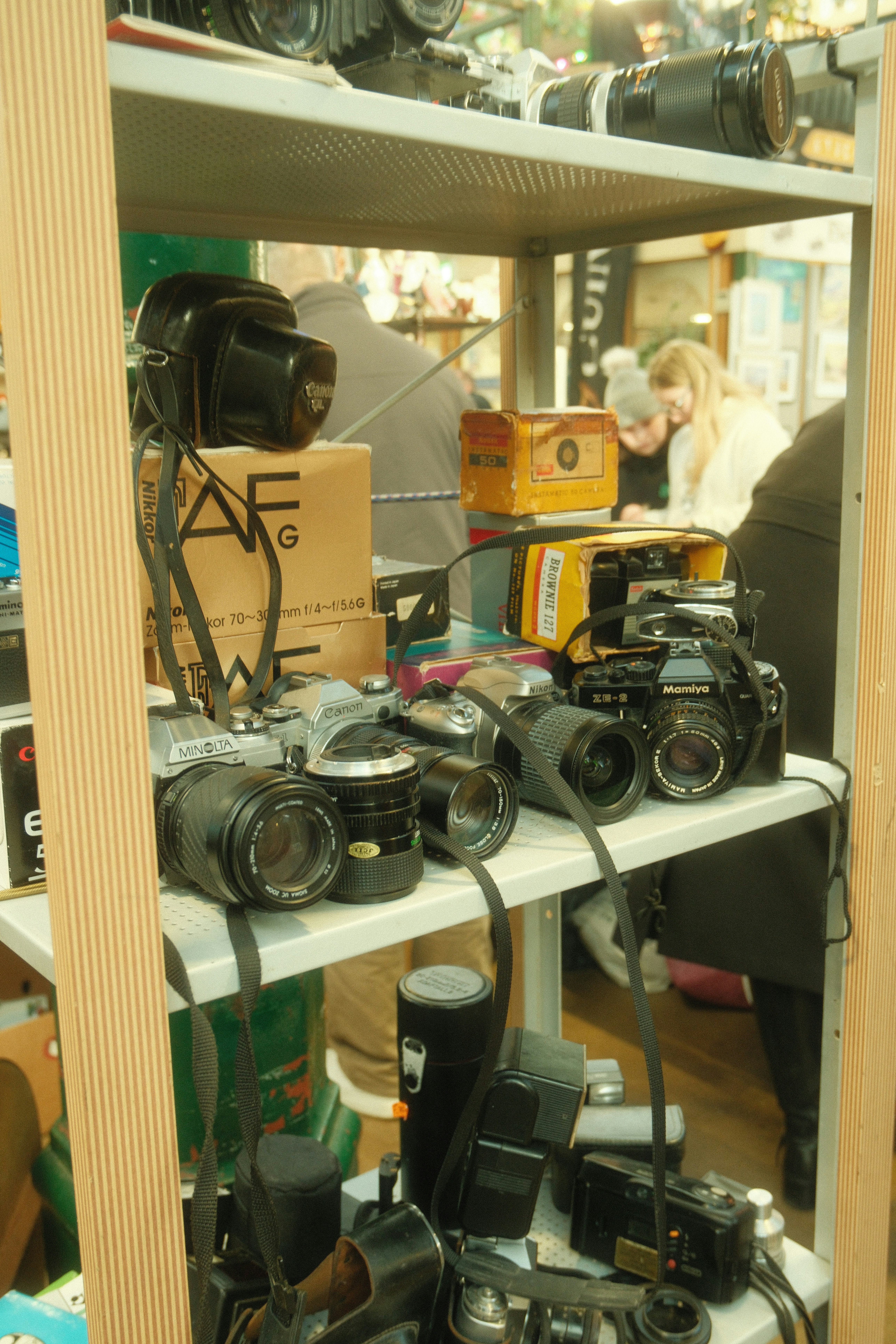 A Vintage Lens Parade on a Busy Display Shelf
