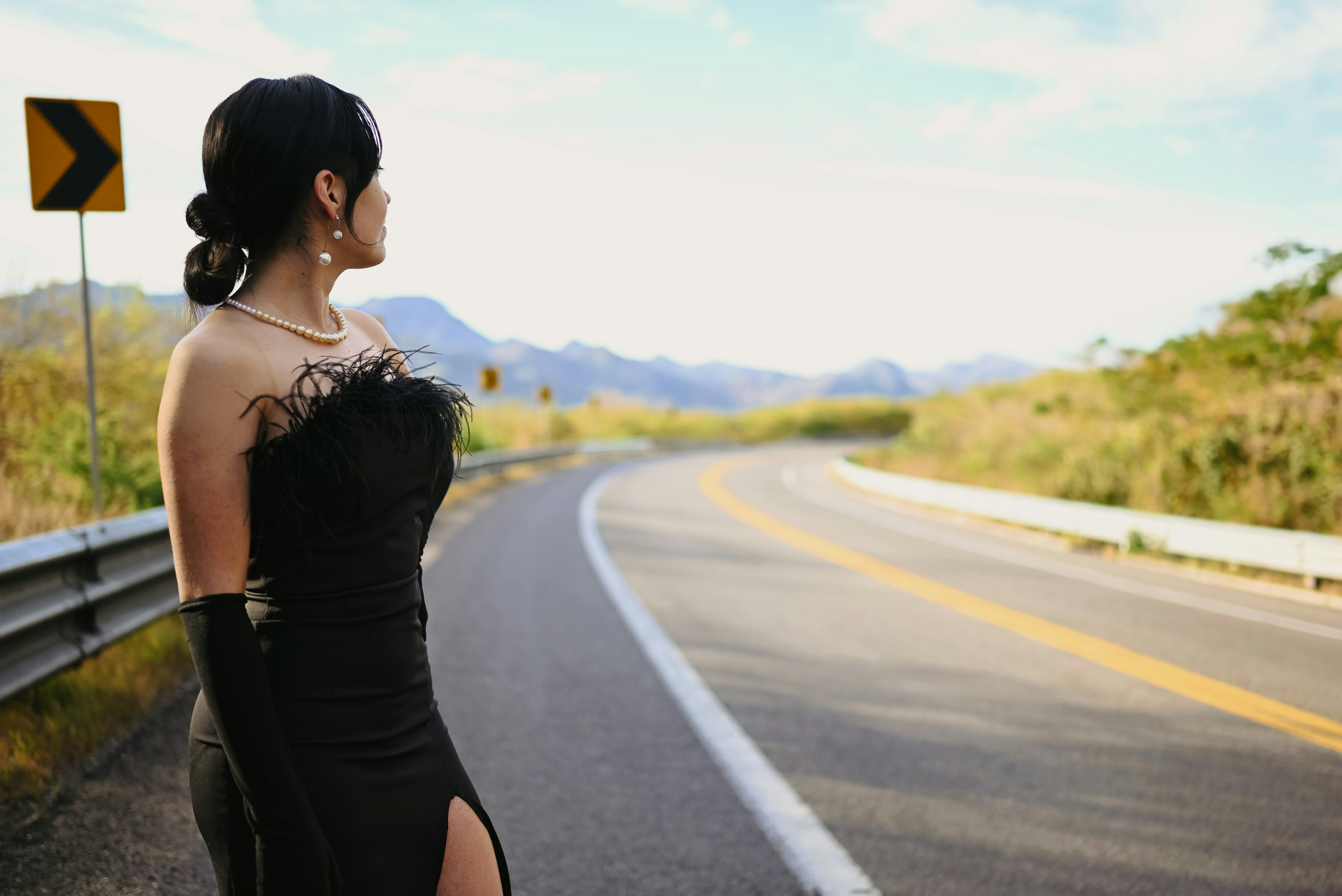 Evening Deco: A Woman in Noir on a Winding Desert Road
