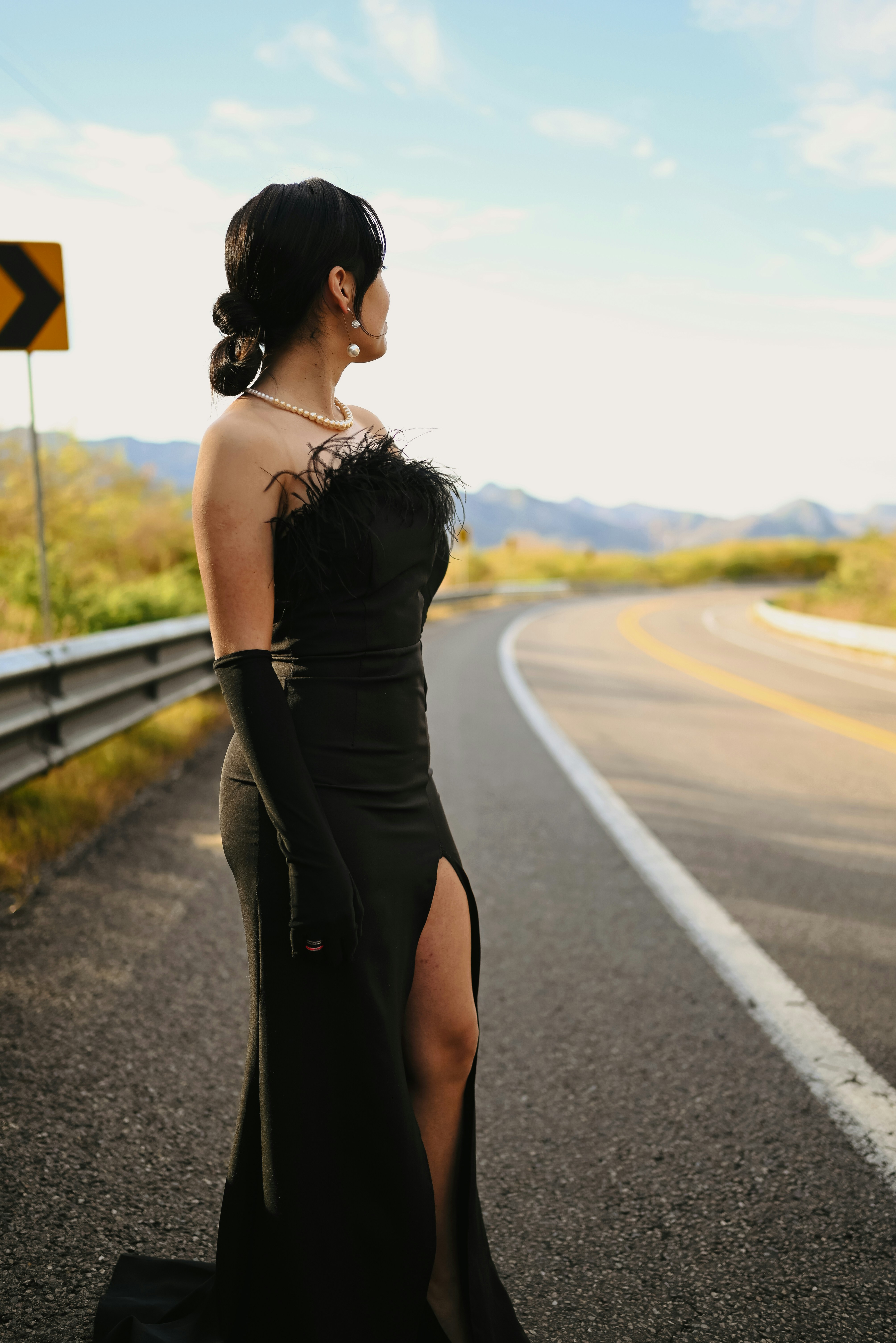 Elegant silhouette on an open road: a black-tie moment bathed in desert light