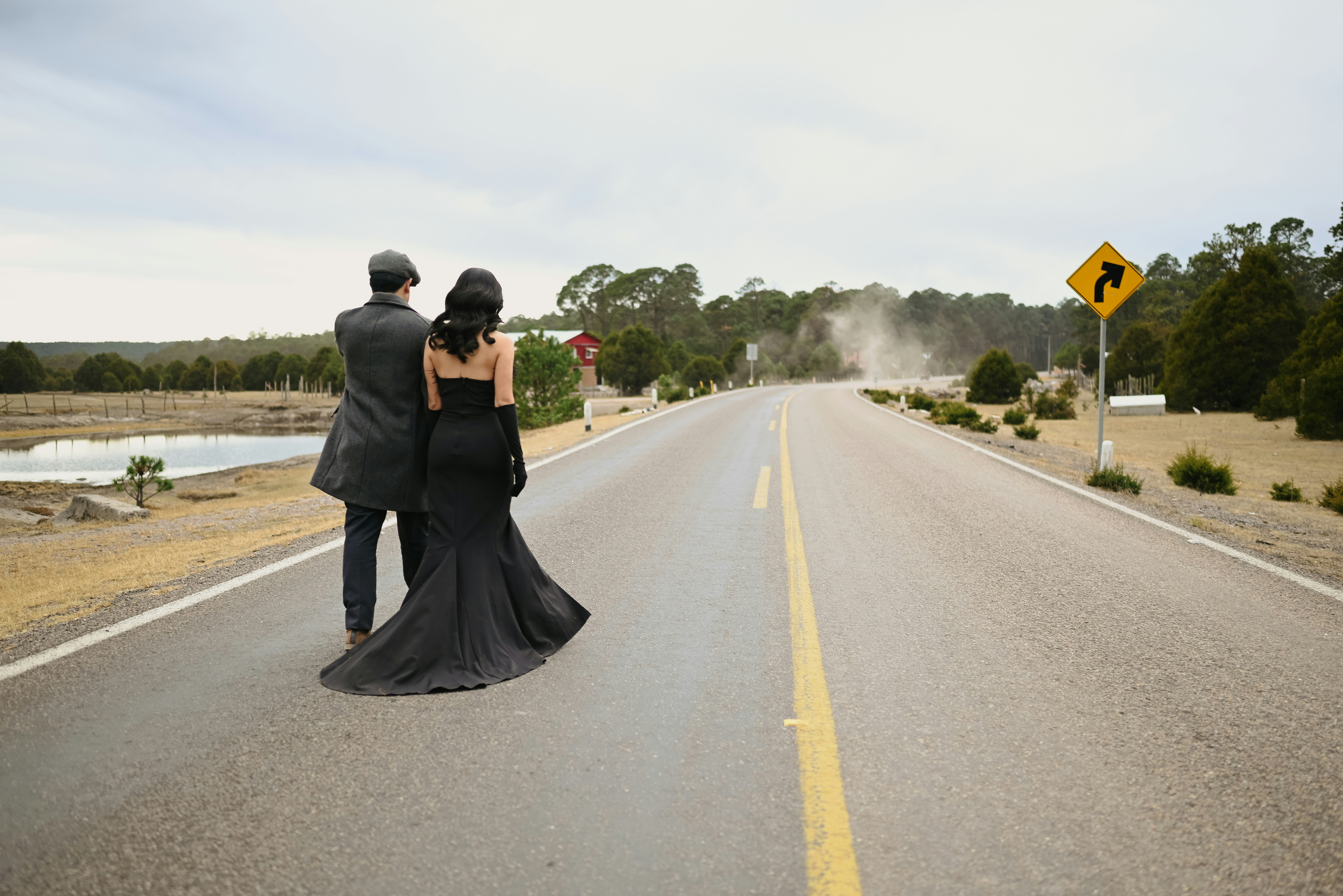 Couple in Elegant Black Against a Deserted Road