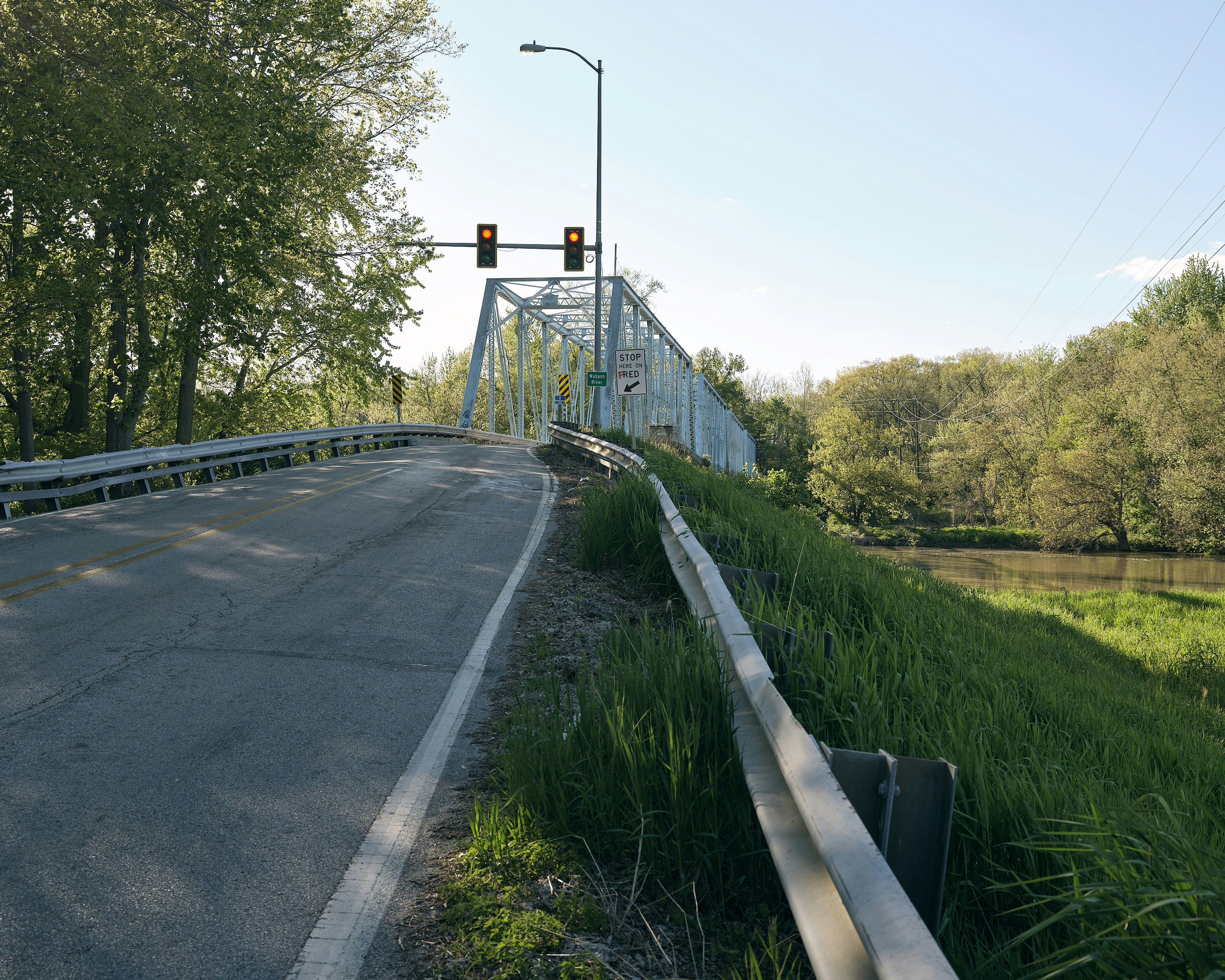 Sunlit Bridge Approach: A Quiet Road to the River