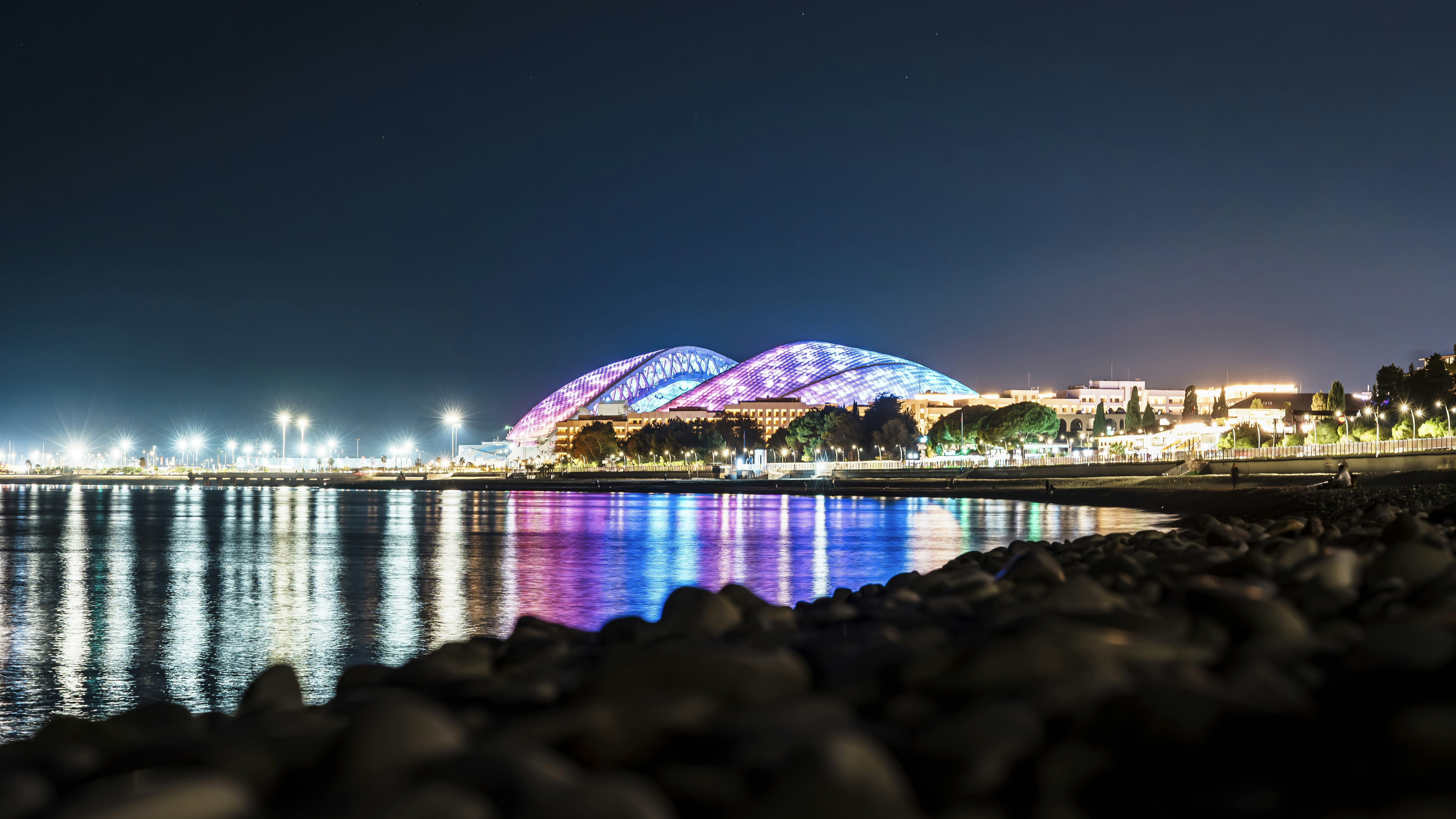 Neon Arches Over a Quiet Waterfront