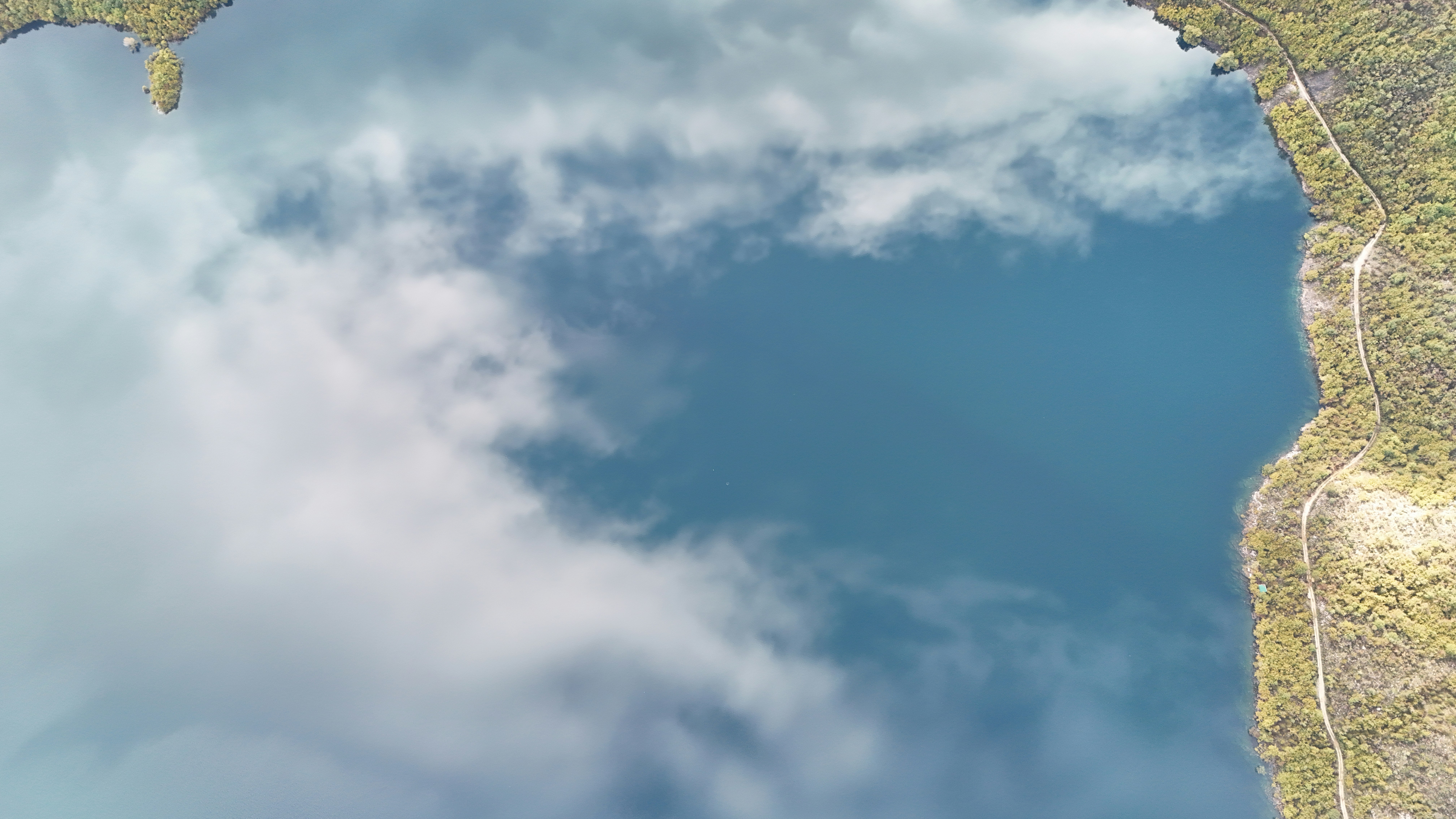 Aerial Rift: Cloud-Soft Sky Over a Narrow Shoreline