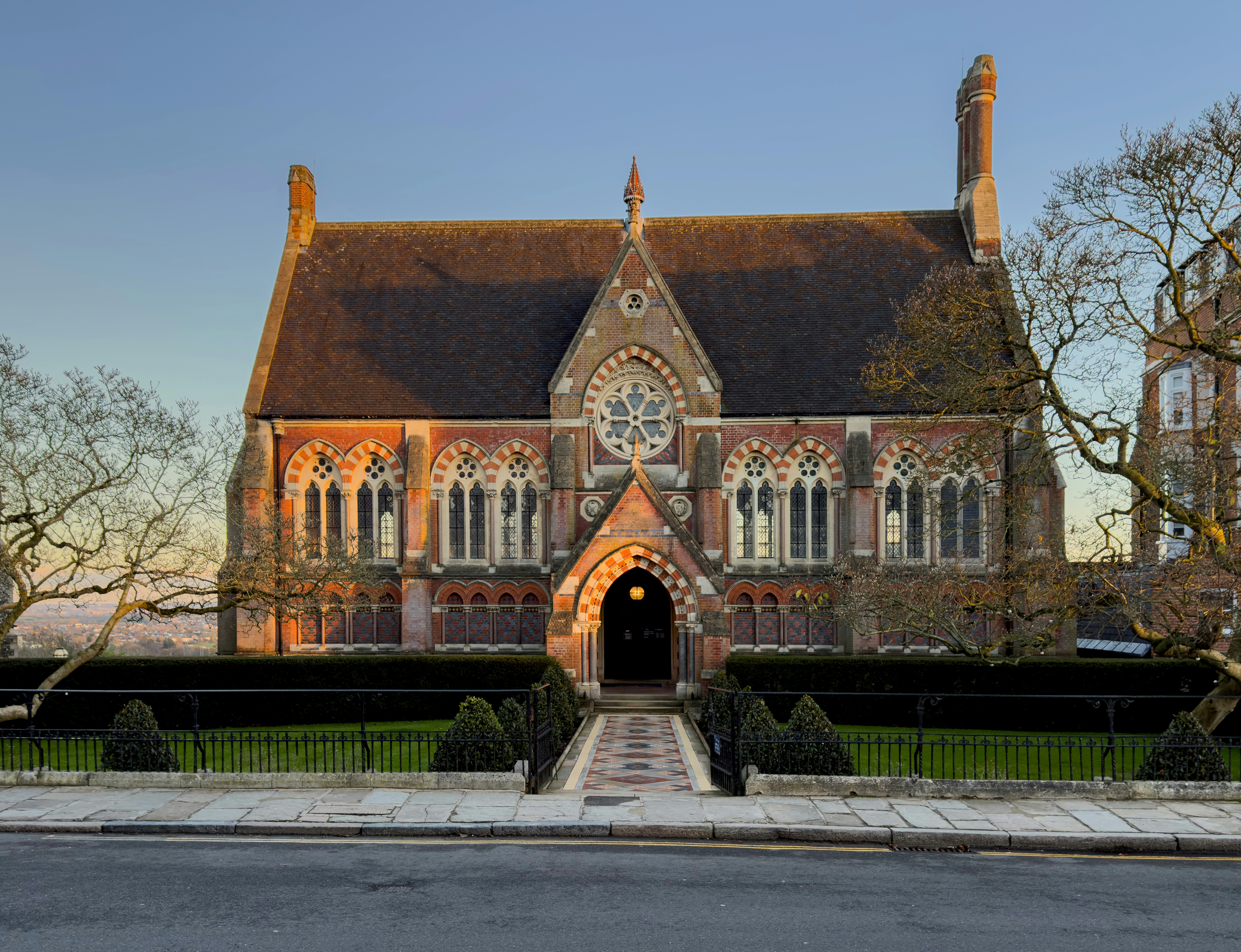 Gothic-arched College Chapel Framed by Sunset Glow