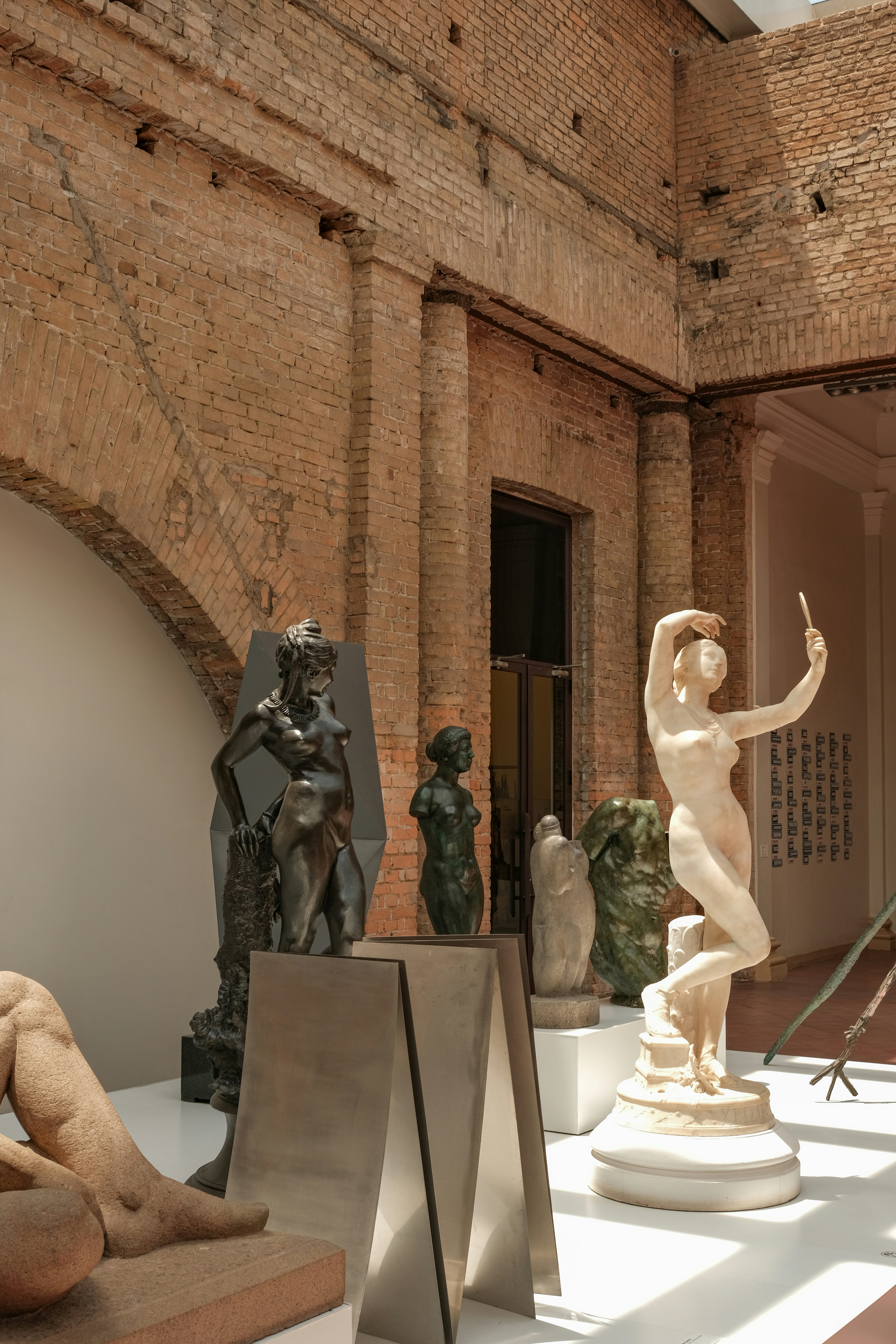Sculpted Gallery Dawn: Classical Figures in a Brick-Chambered Atrium