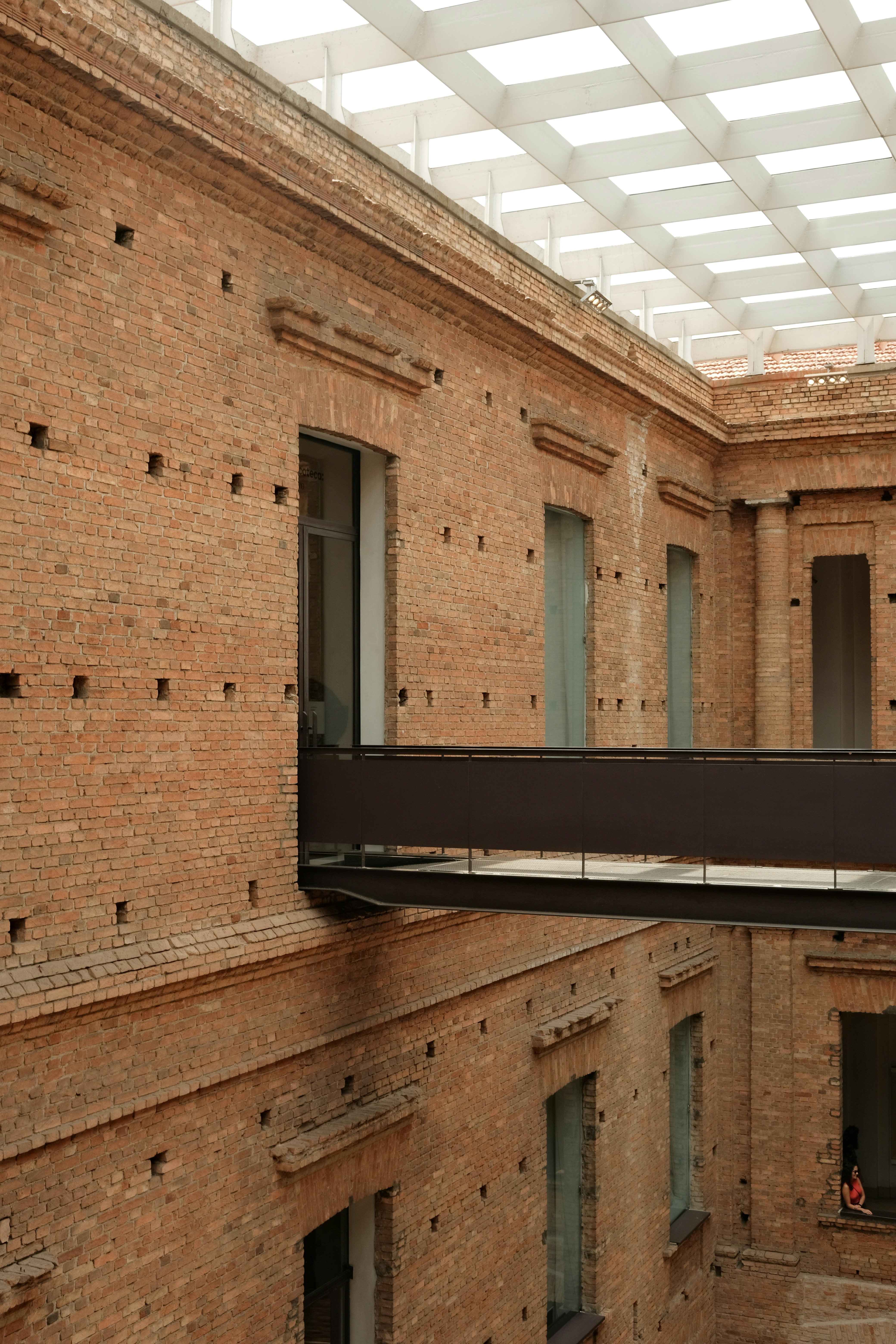 Brick Atrium Overlook: Sunlit Veranda Bridge in a Heritage Hall