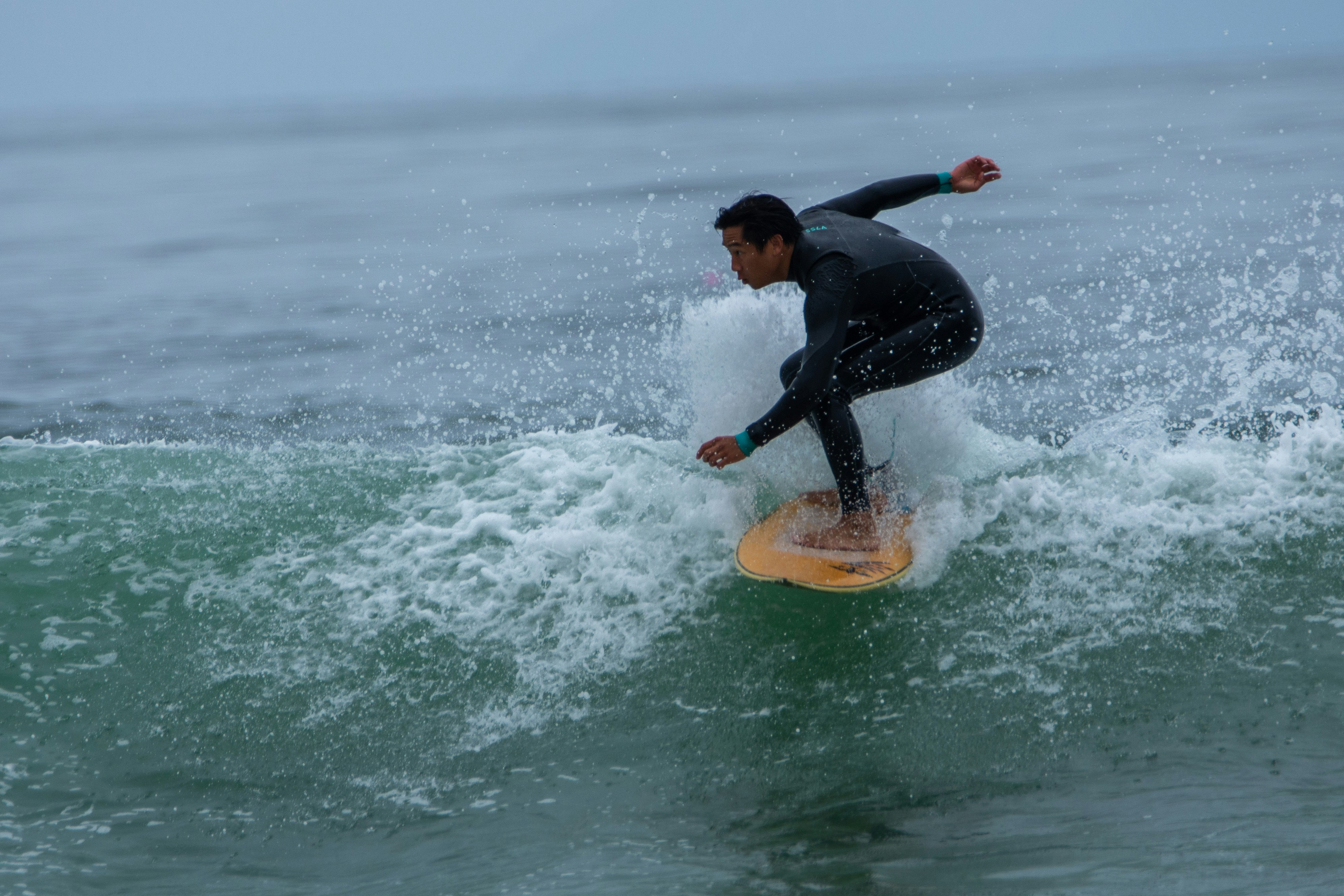 Frontside Wave Rider in Mid-Tloat: Surfing a Cresting Green Wall