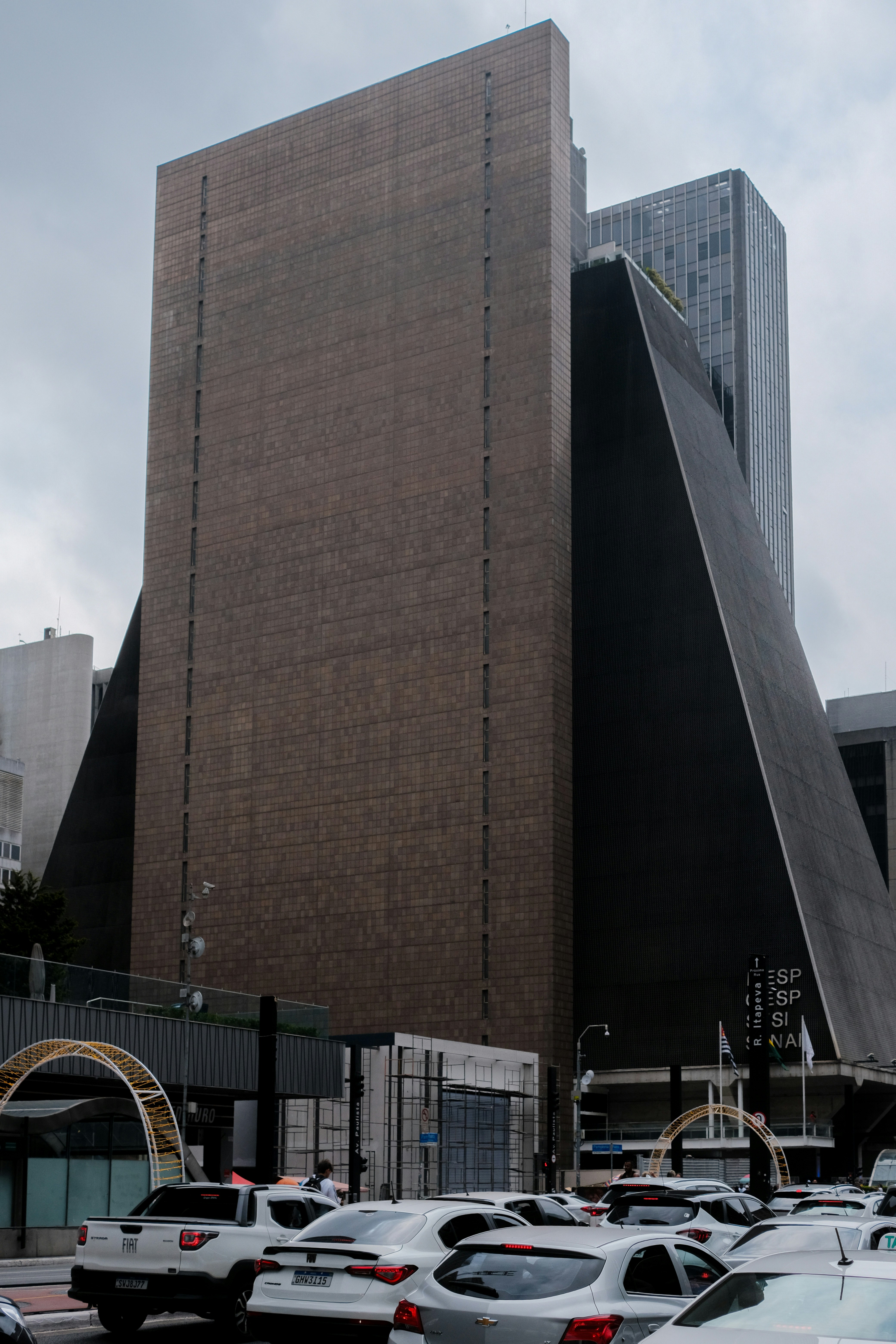 Monolithic Brick Tower Framing a City in Motion