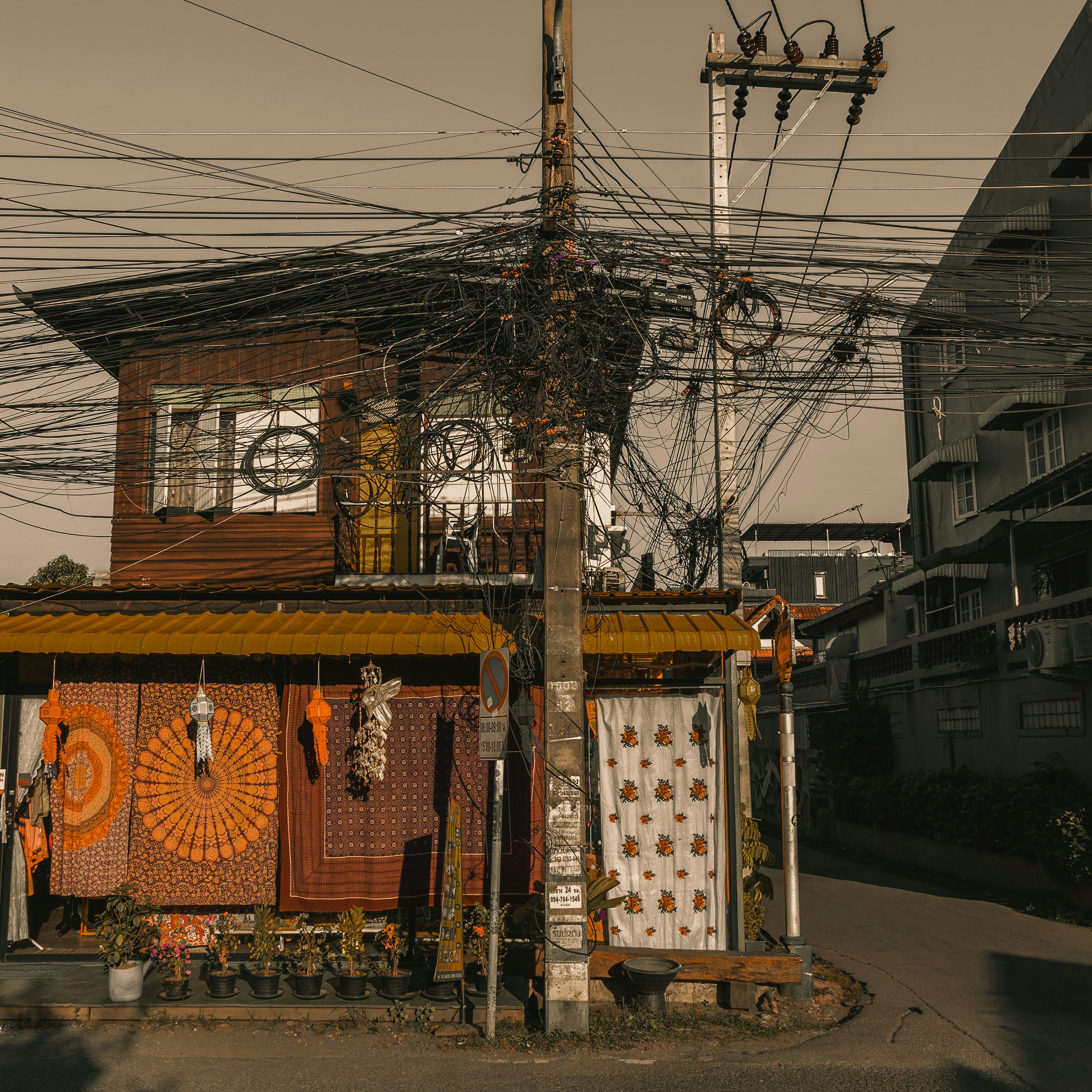 Wires and Wares: A Quiet Street Market Under a Tangle of Cables