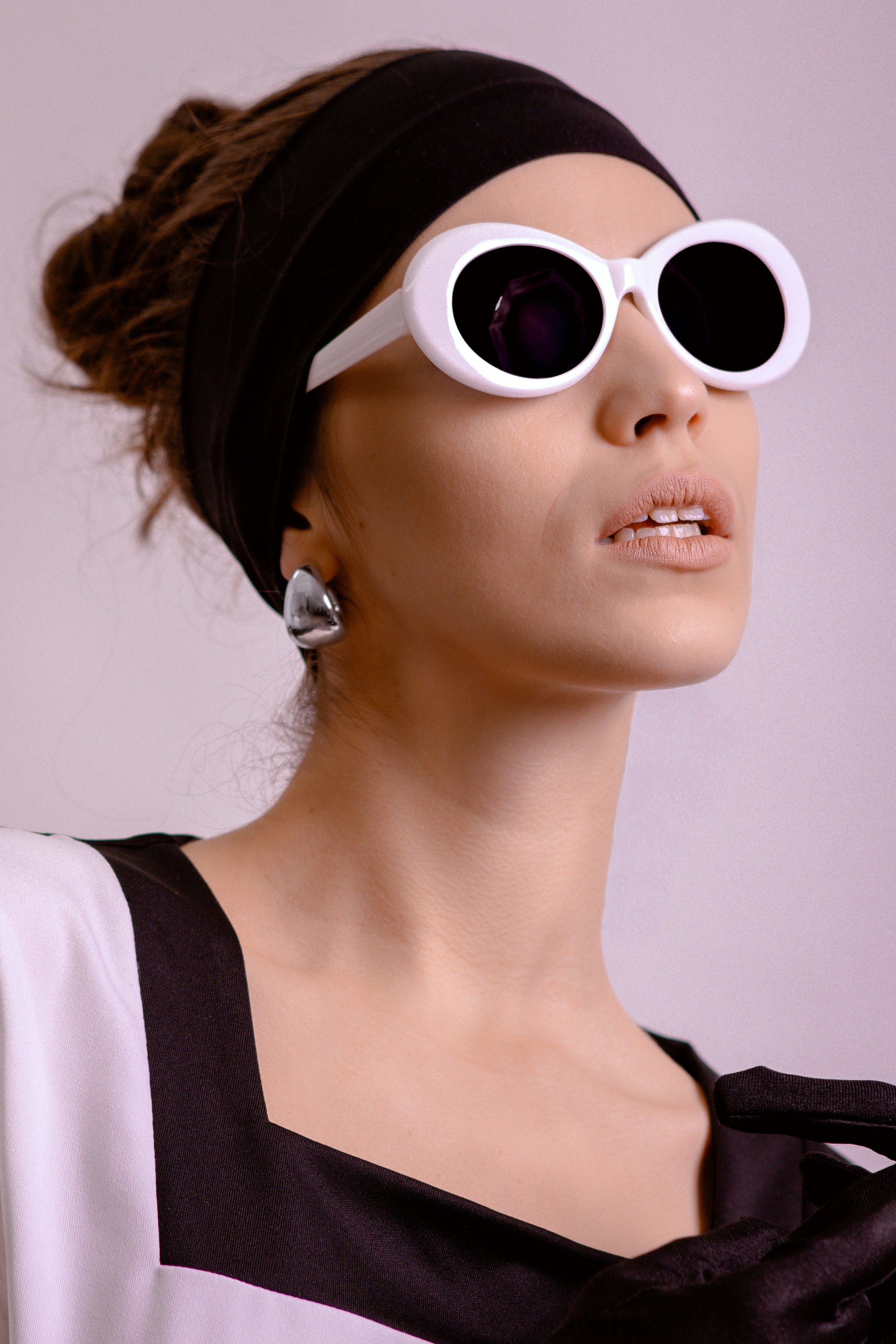 Retro Chic: The Face Behind Big White Rims in Soft Pink Light