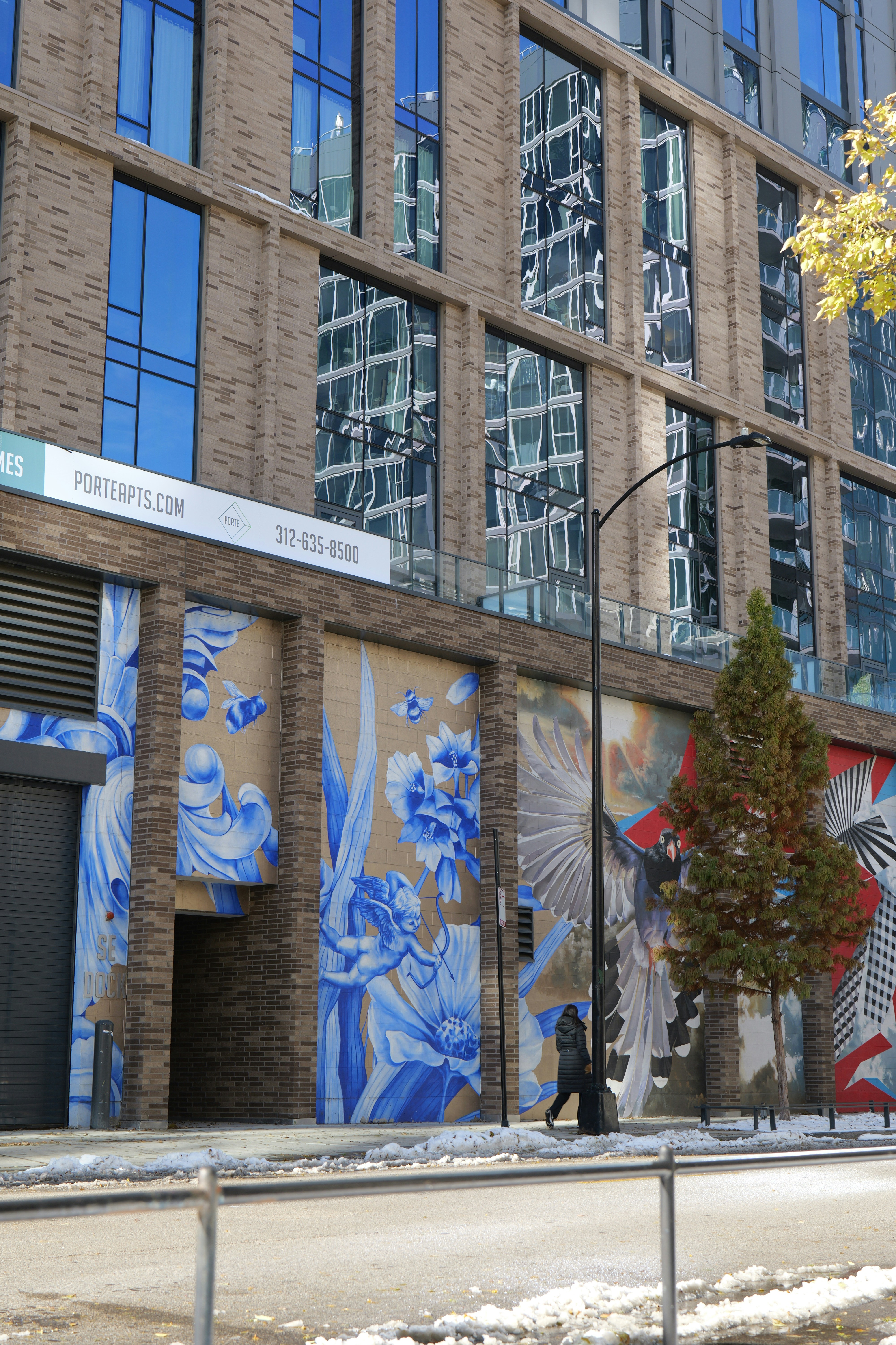 Blue Murals Fronting a Modern Brick Facade