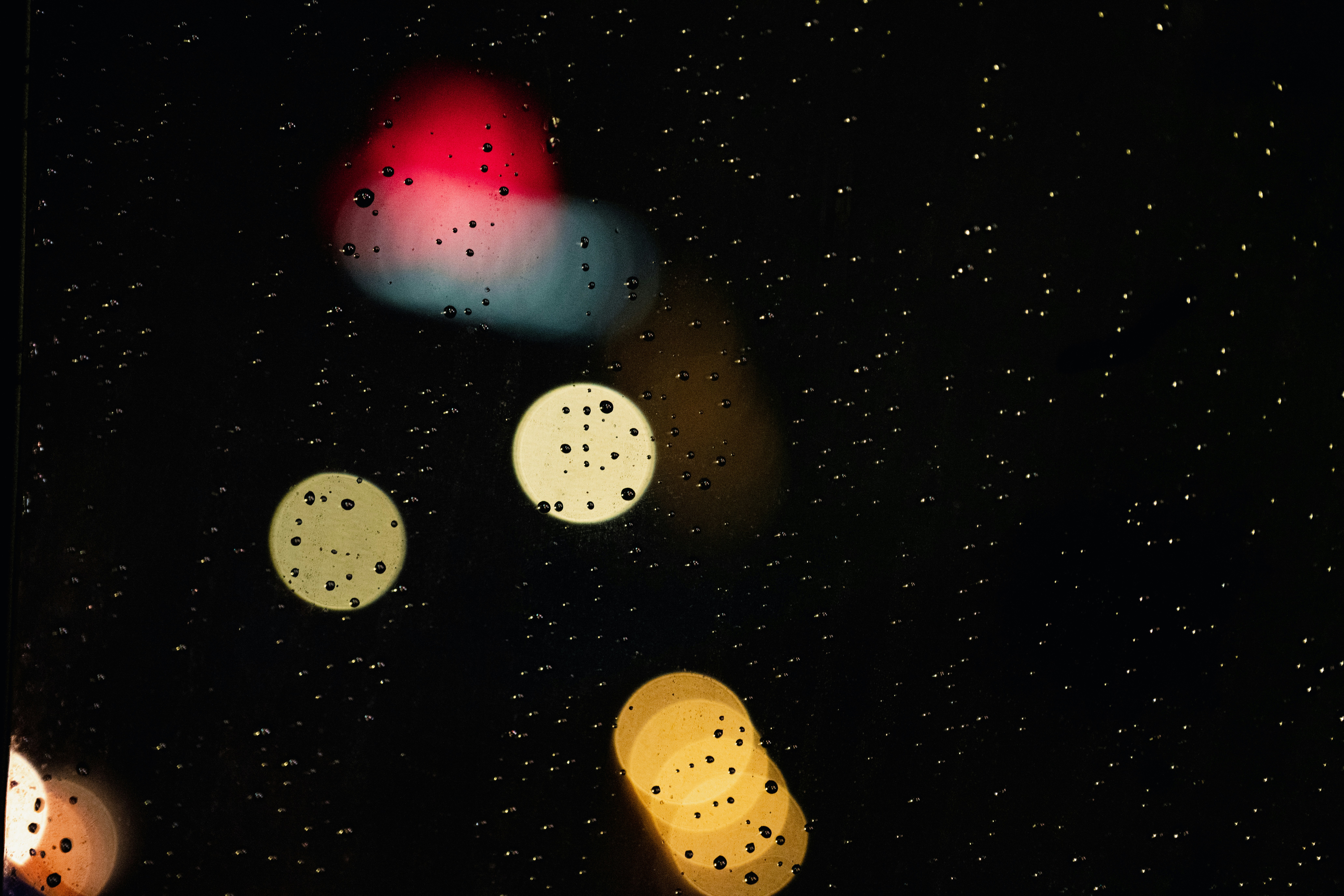 Bokeh Nightscape: Neon Orbs Behind Rain-Speckled Glass