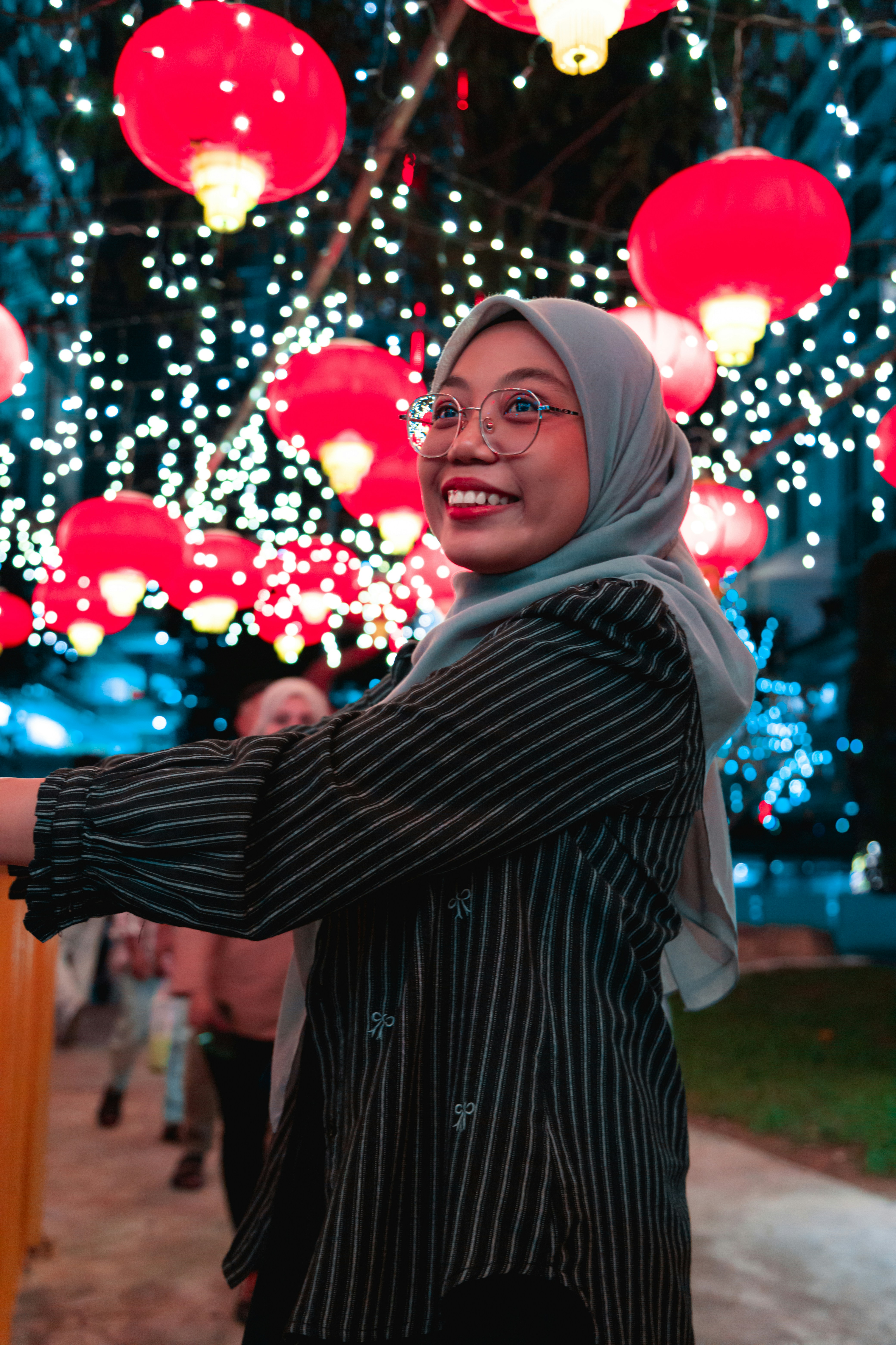 Joy in the Lantern Glow: A Portrait Beneath Festive Lights
