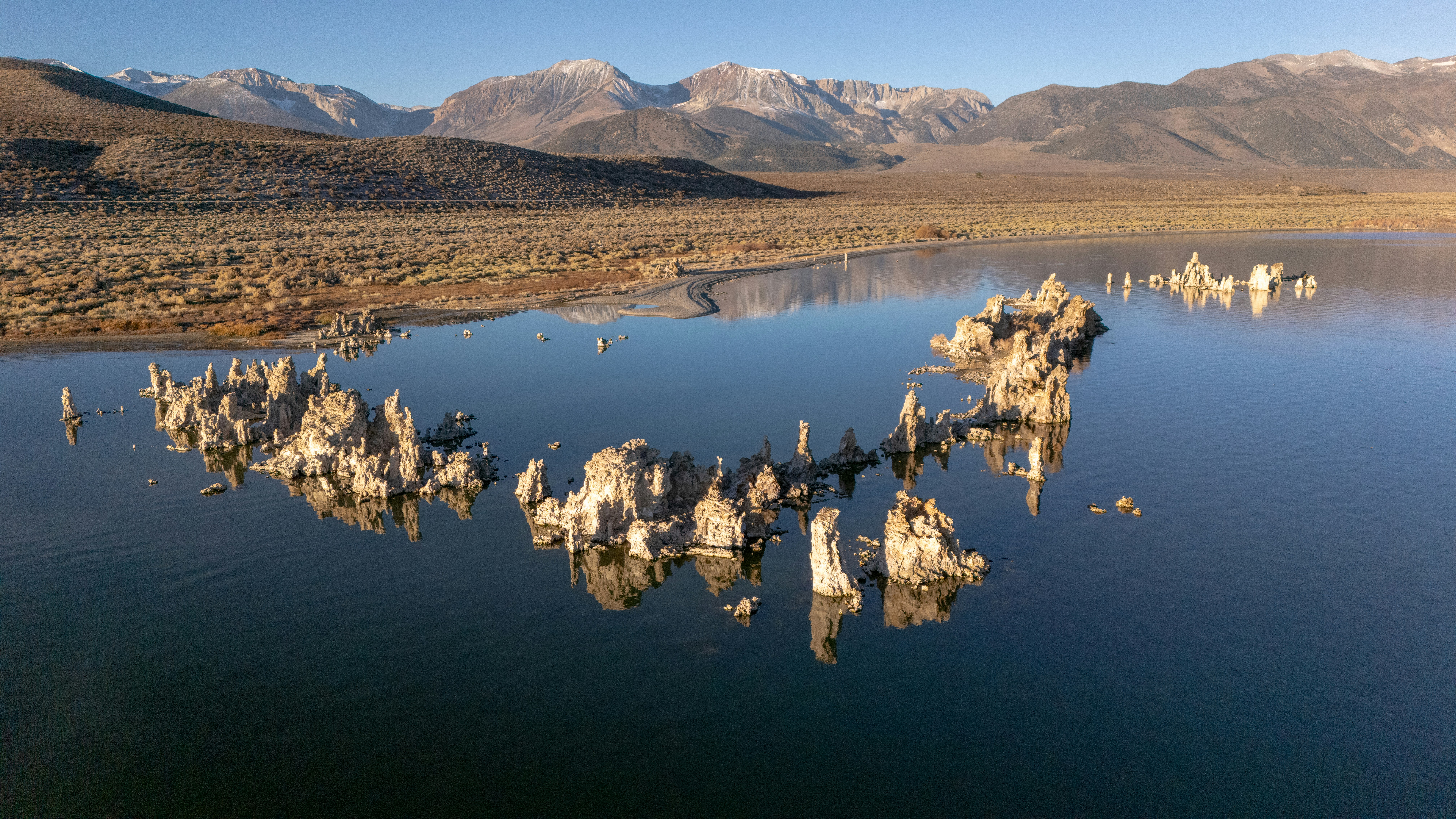 Salt Echoes: Sunlit Tufa Spires in a Desert Lake Arc
