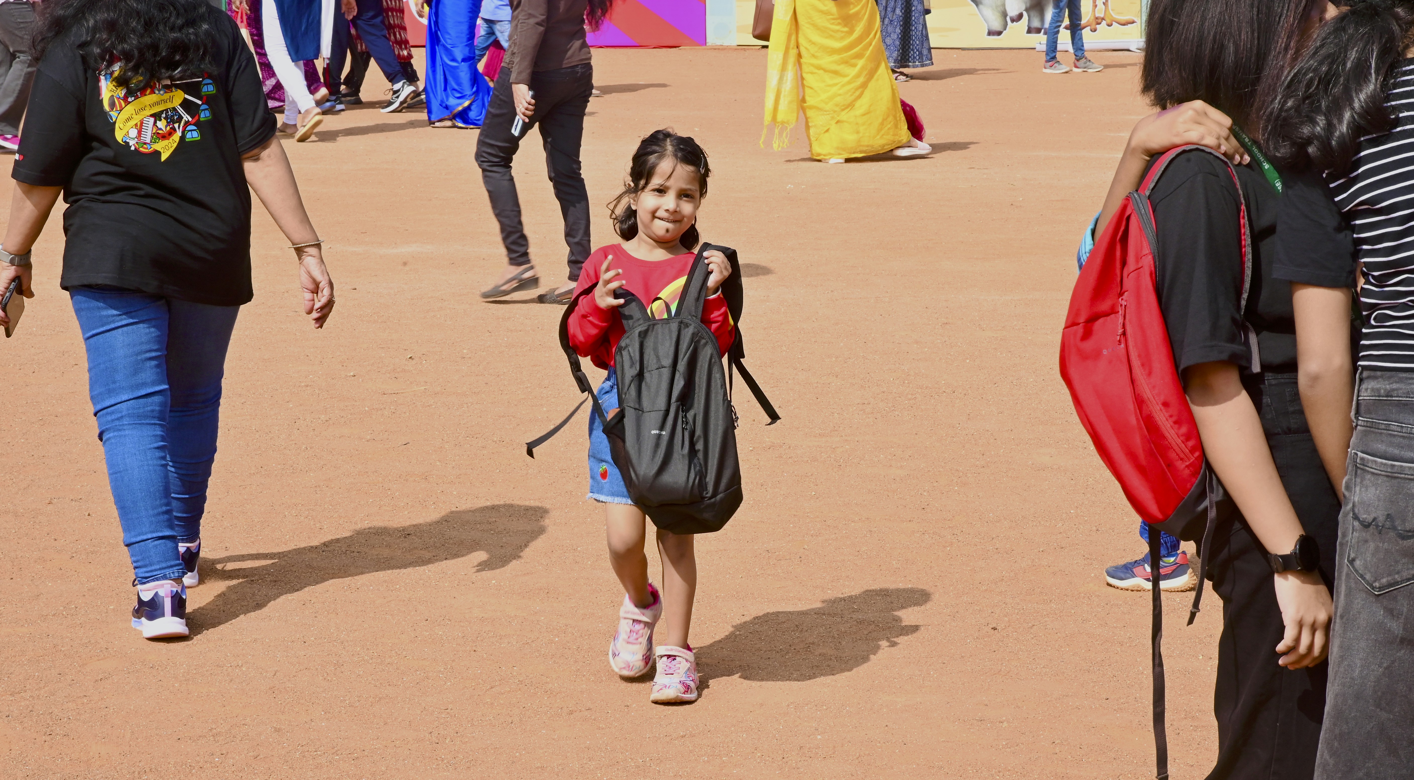 Little Explorer with a Backpack at the Festival Grounds