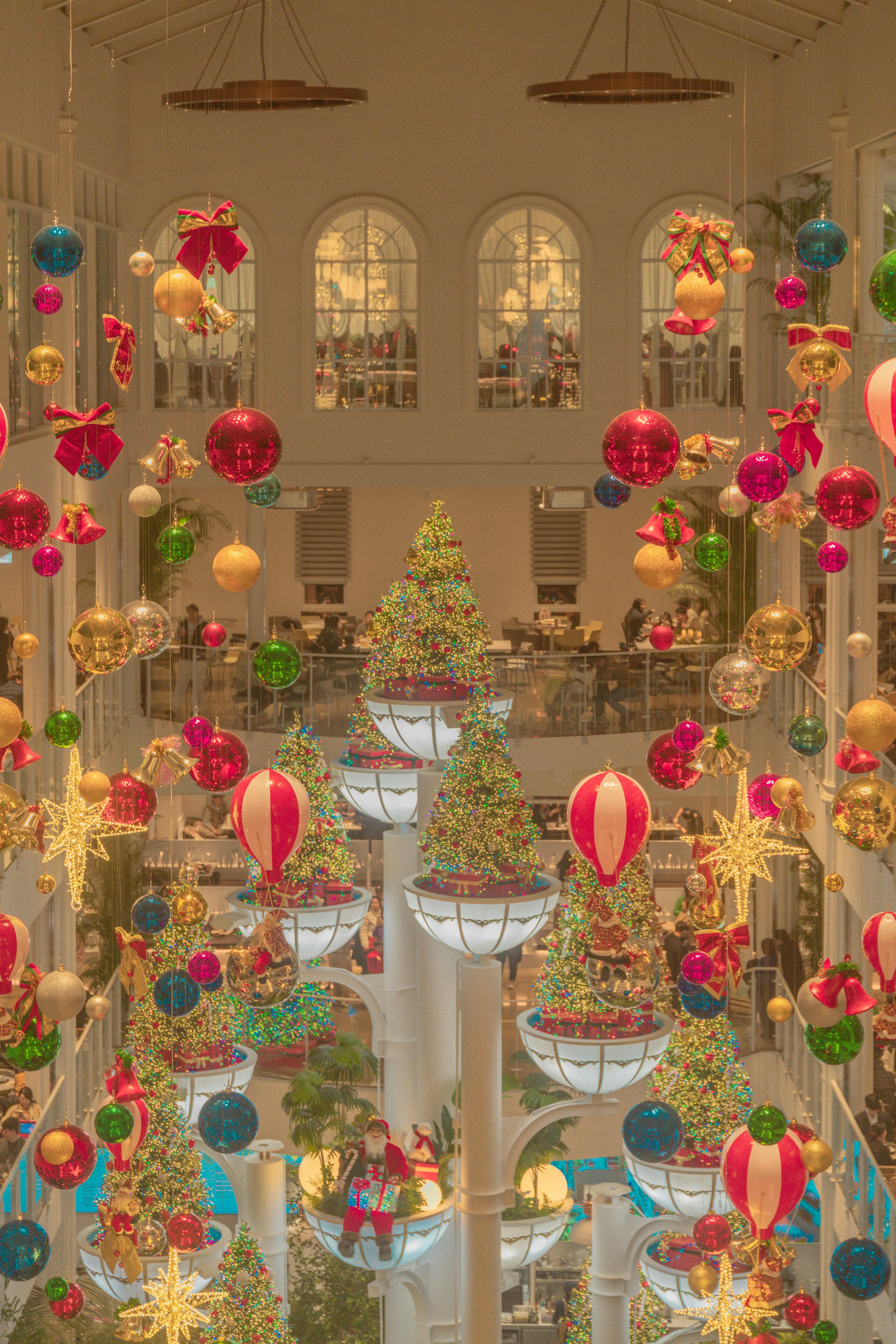 Ornamented Atrium: A Winter Wonderland of Hanging Orbs and Festive Trees