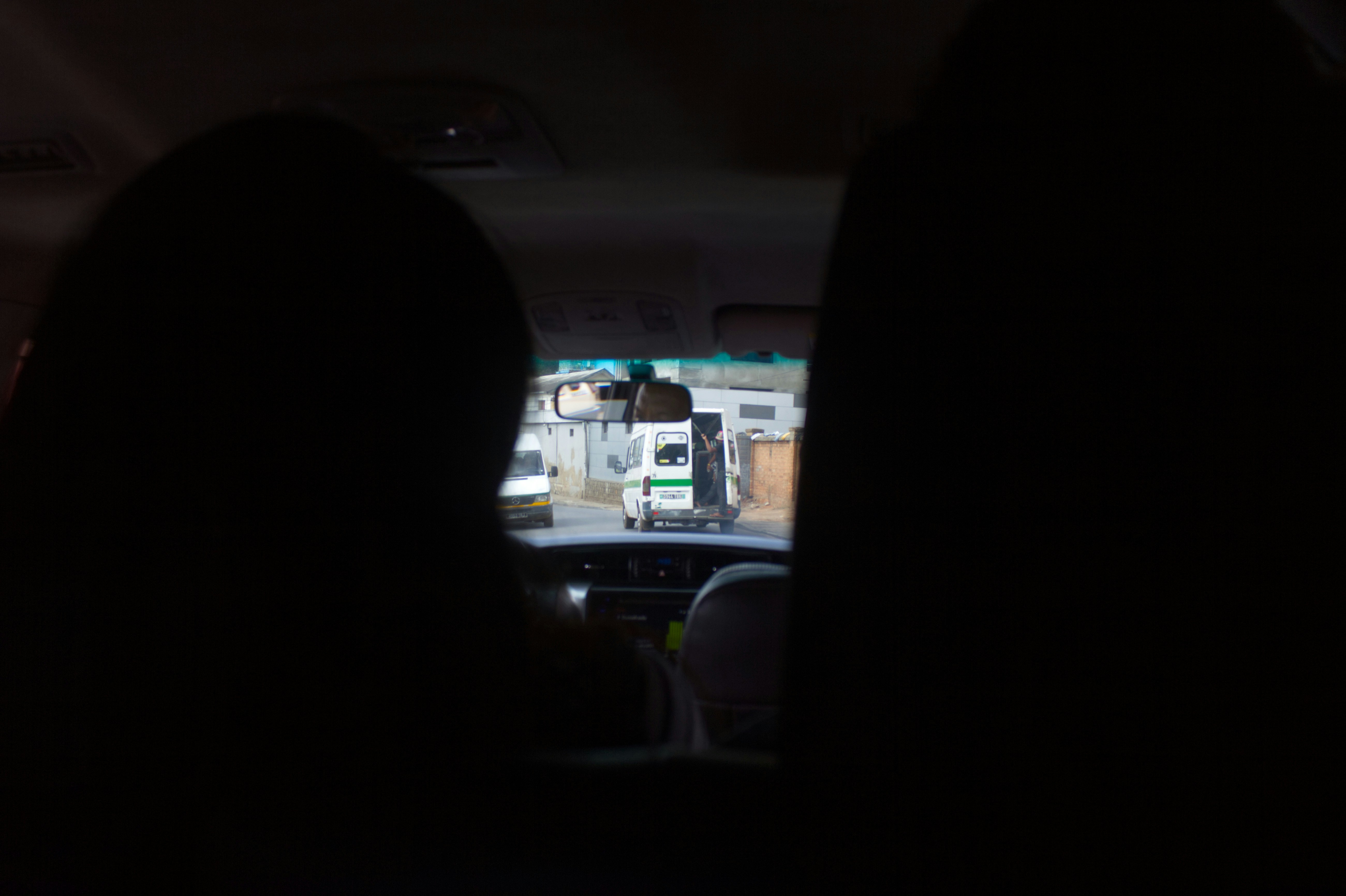 Midnight Drive: A Shrouded Car Interior Gazes toward the Busy Road Ahead