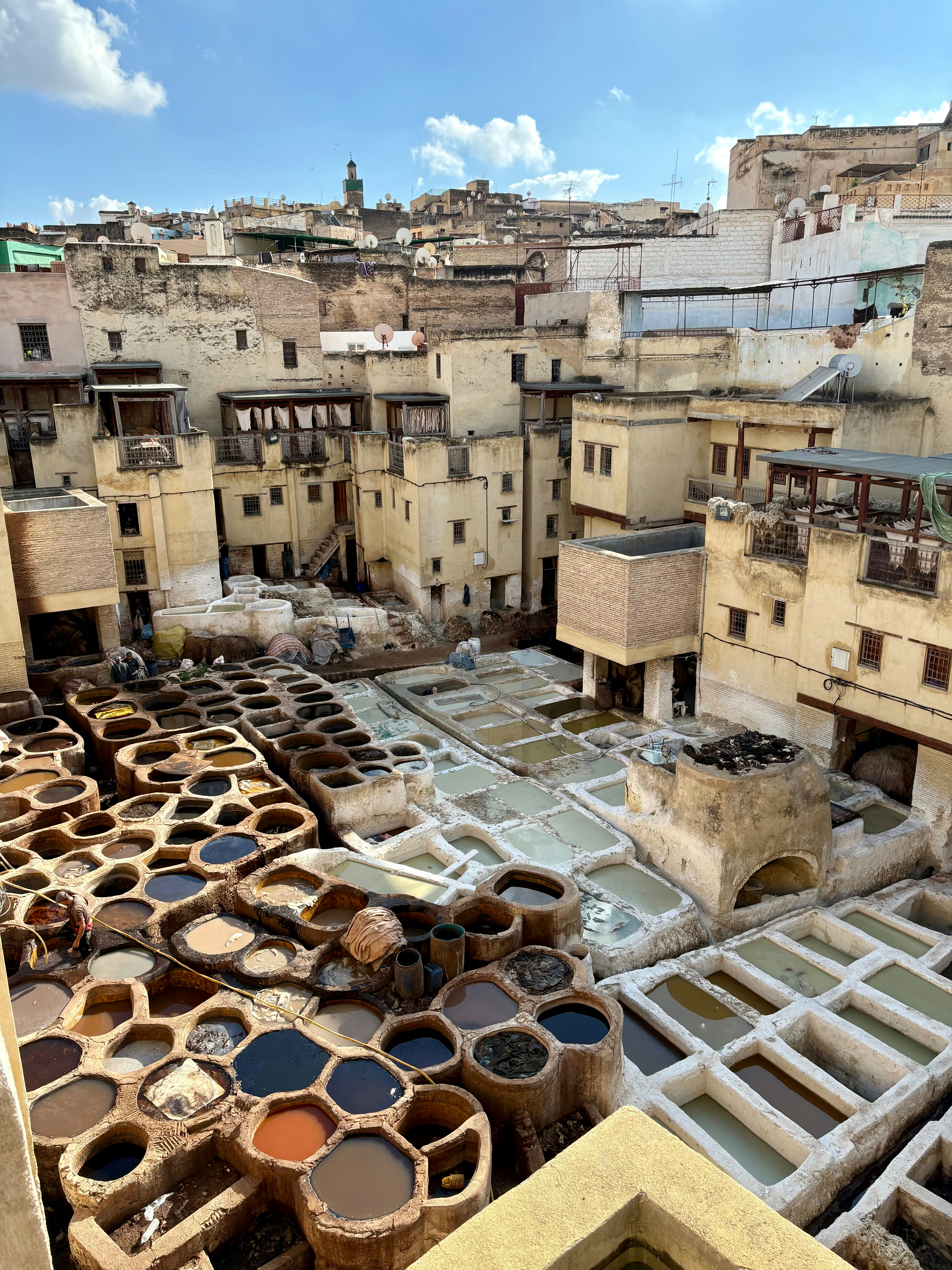 Rooftop Dyework Oasis: Pools and Terraced Hives Amid Crumbling Medina