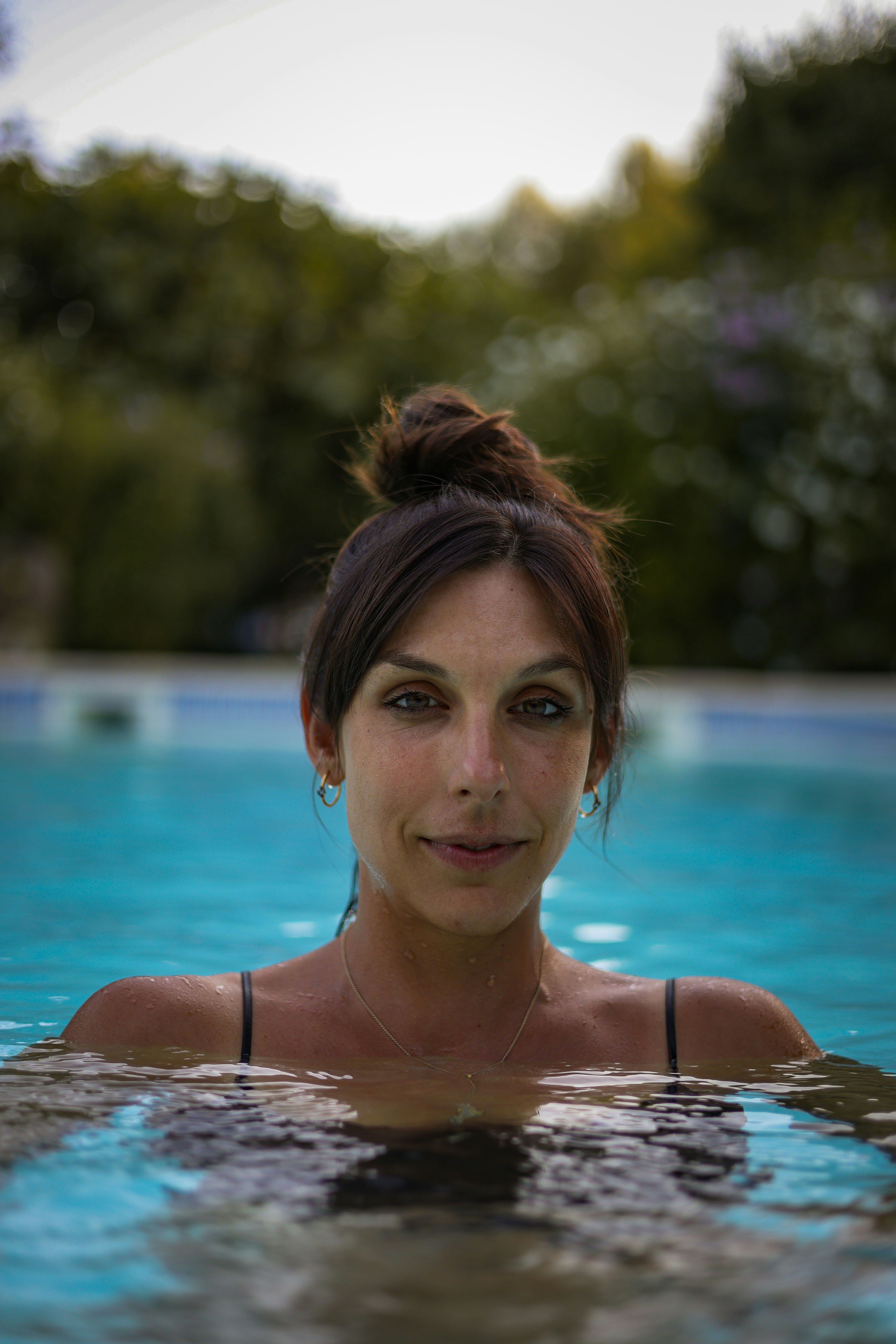 Face Above Water: Quiet Confidence in a Pool Portrait