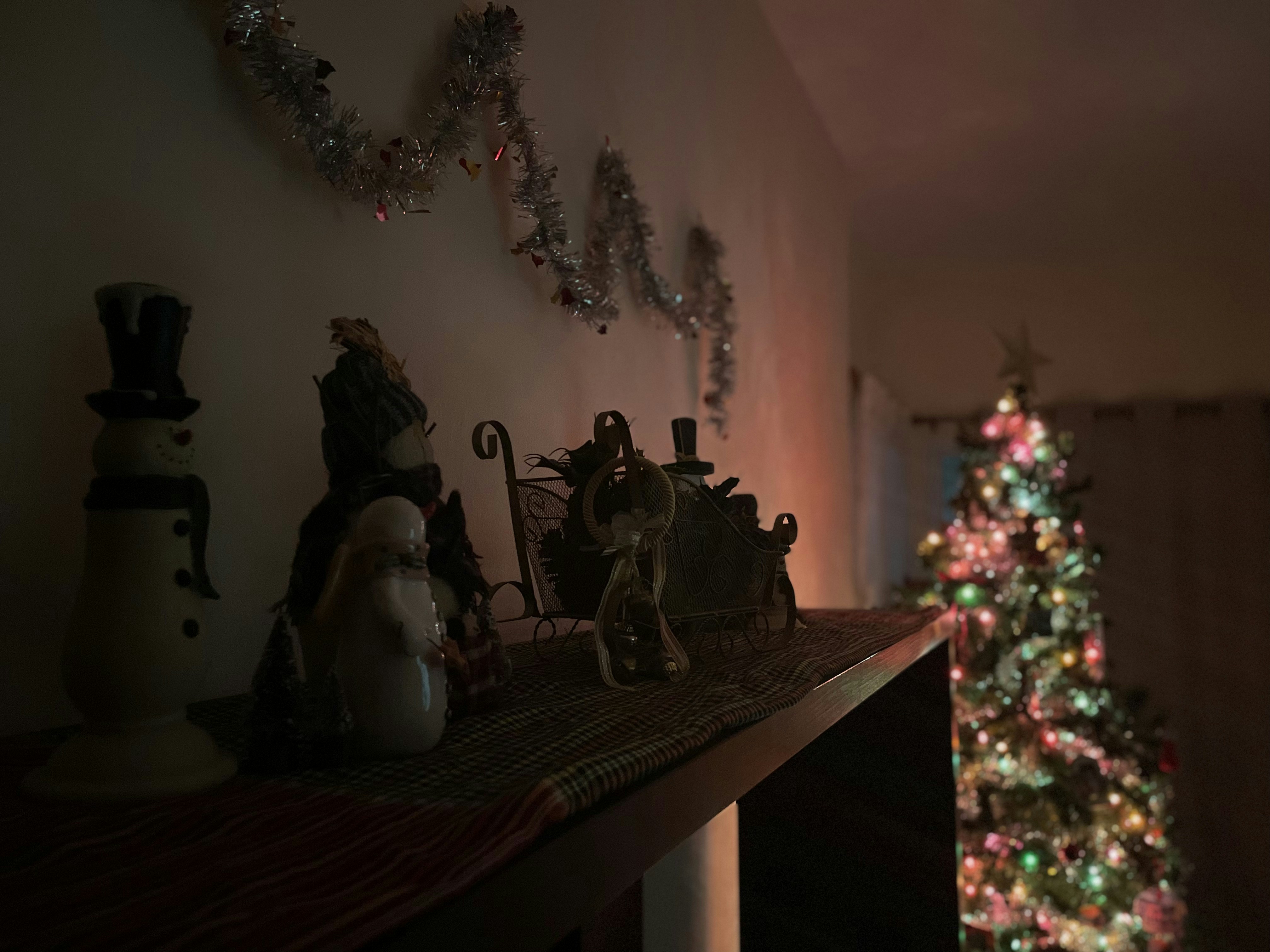 Flickering Holiday Shelf: Tiny Figurines under Dim Glow