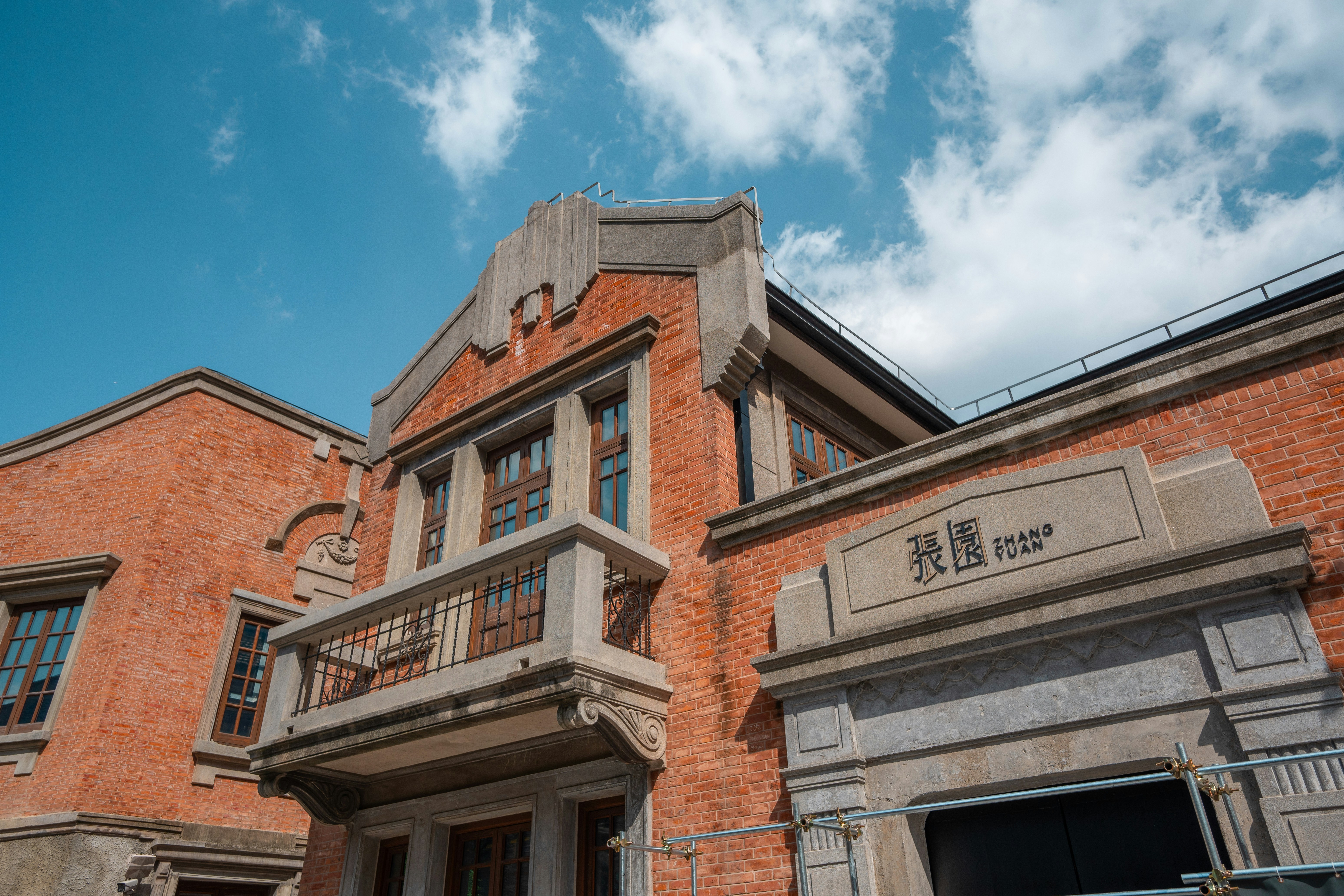 Old brick building with a balcony under blue sky. photo – Free Window ...