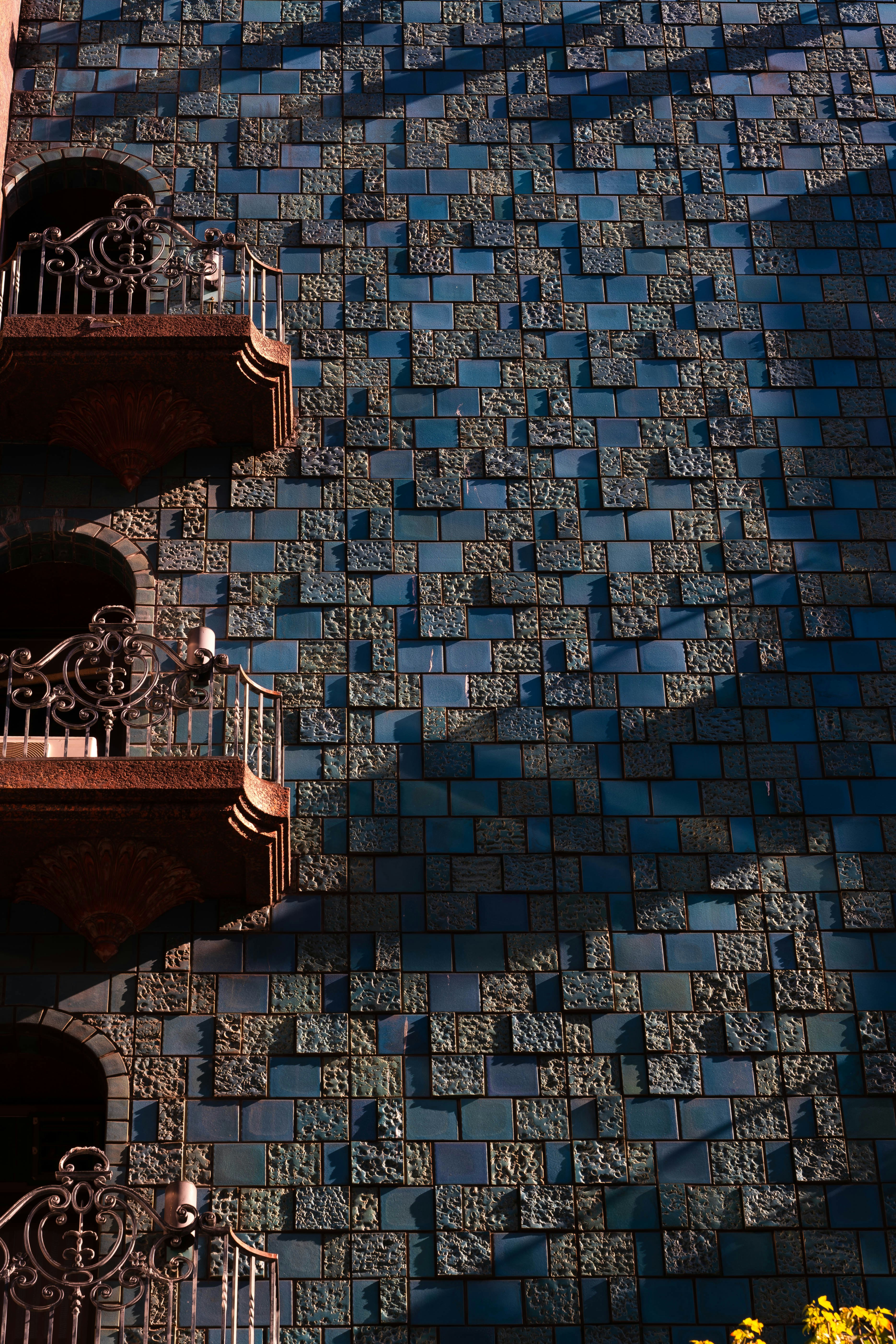 Blue-Tiled Facade with Corner Balcony Ornaments