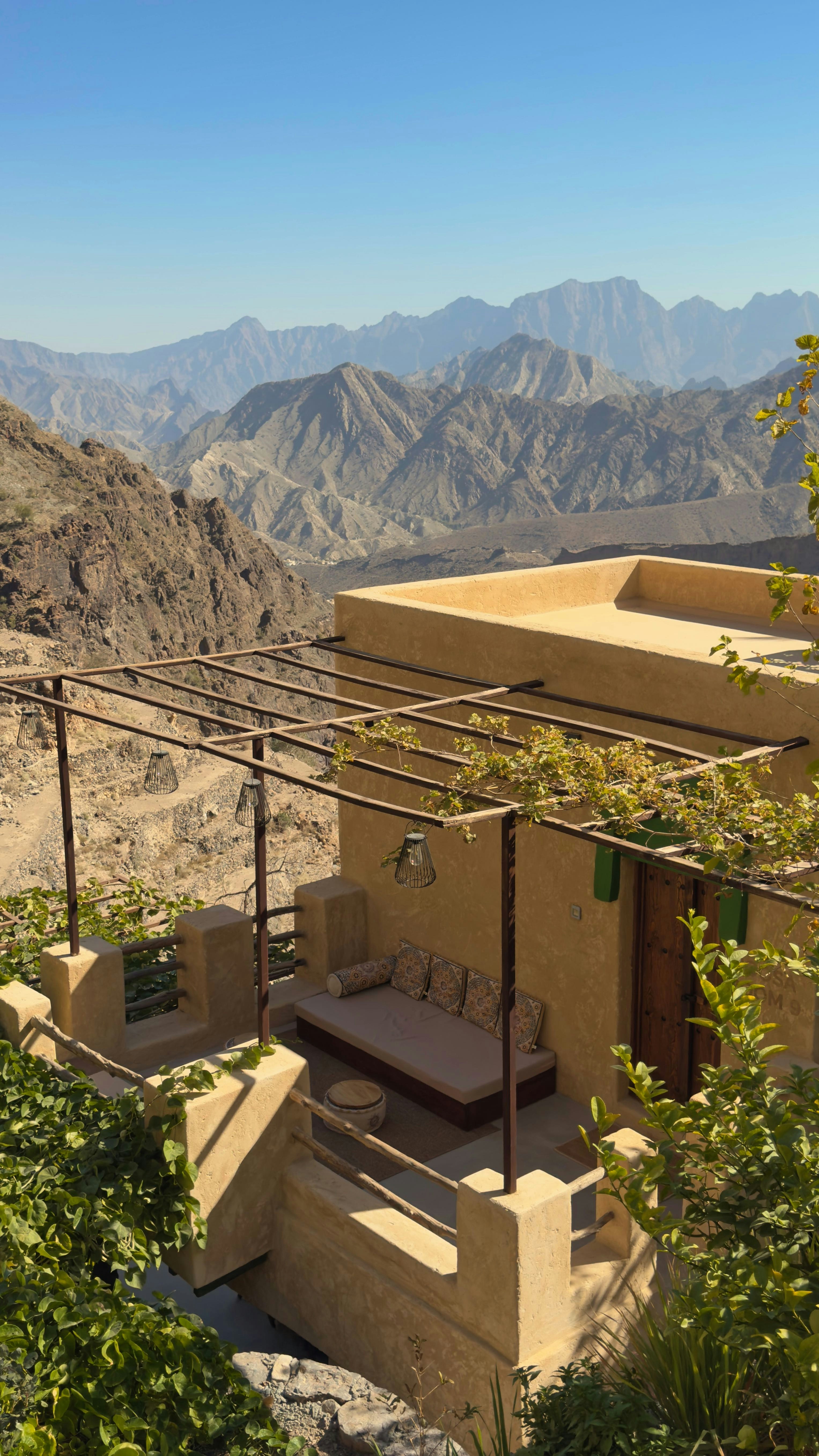 Terrace with desert cabin under a jagged mountain skyline