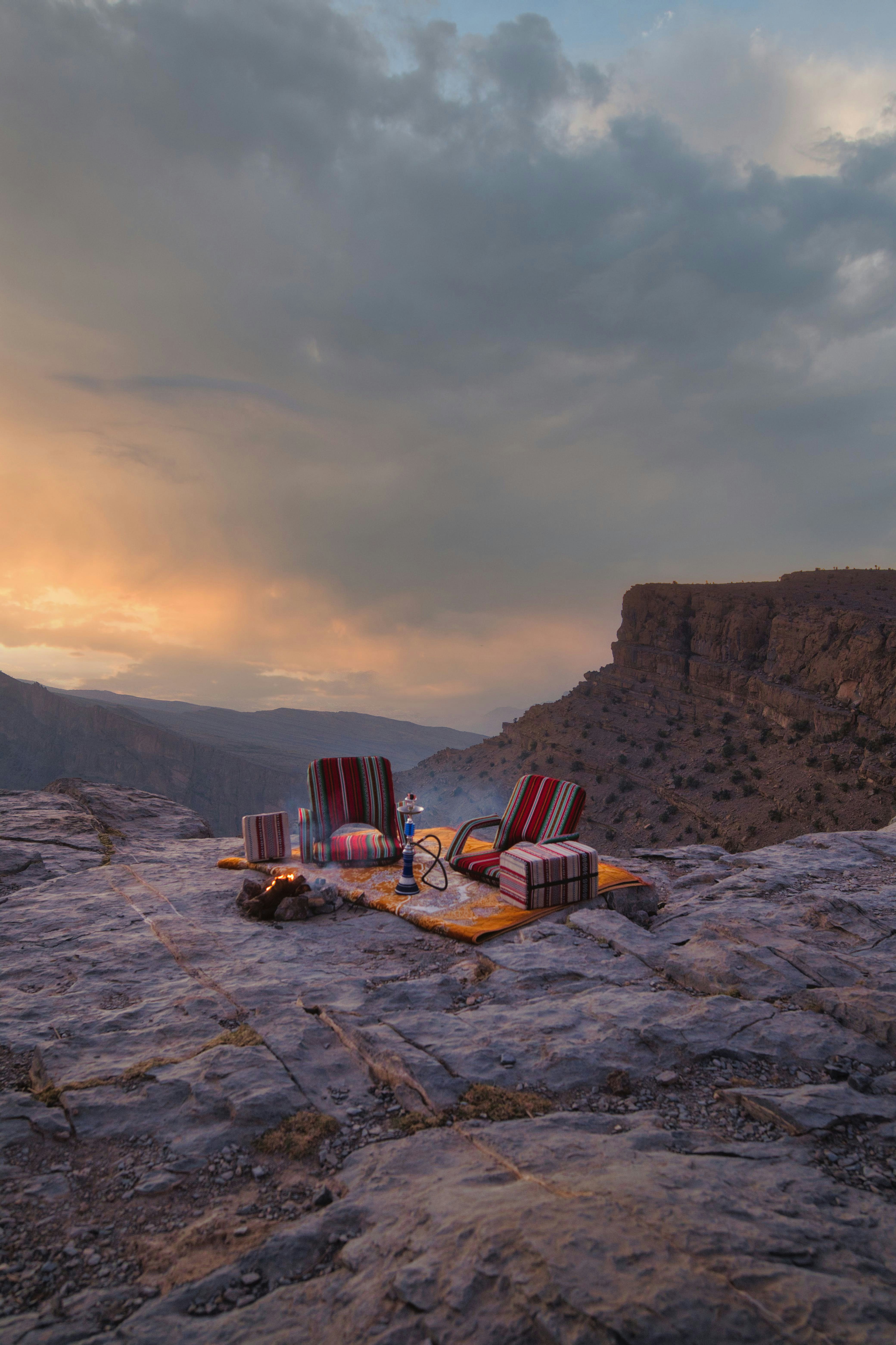 Desert Sunset Lounge: Chairs and Lanterns on a Cliff Edge