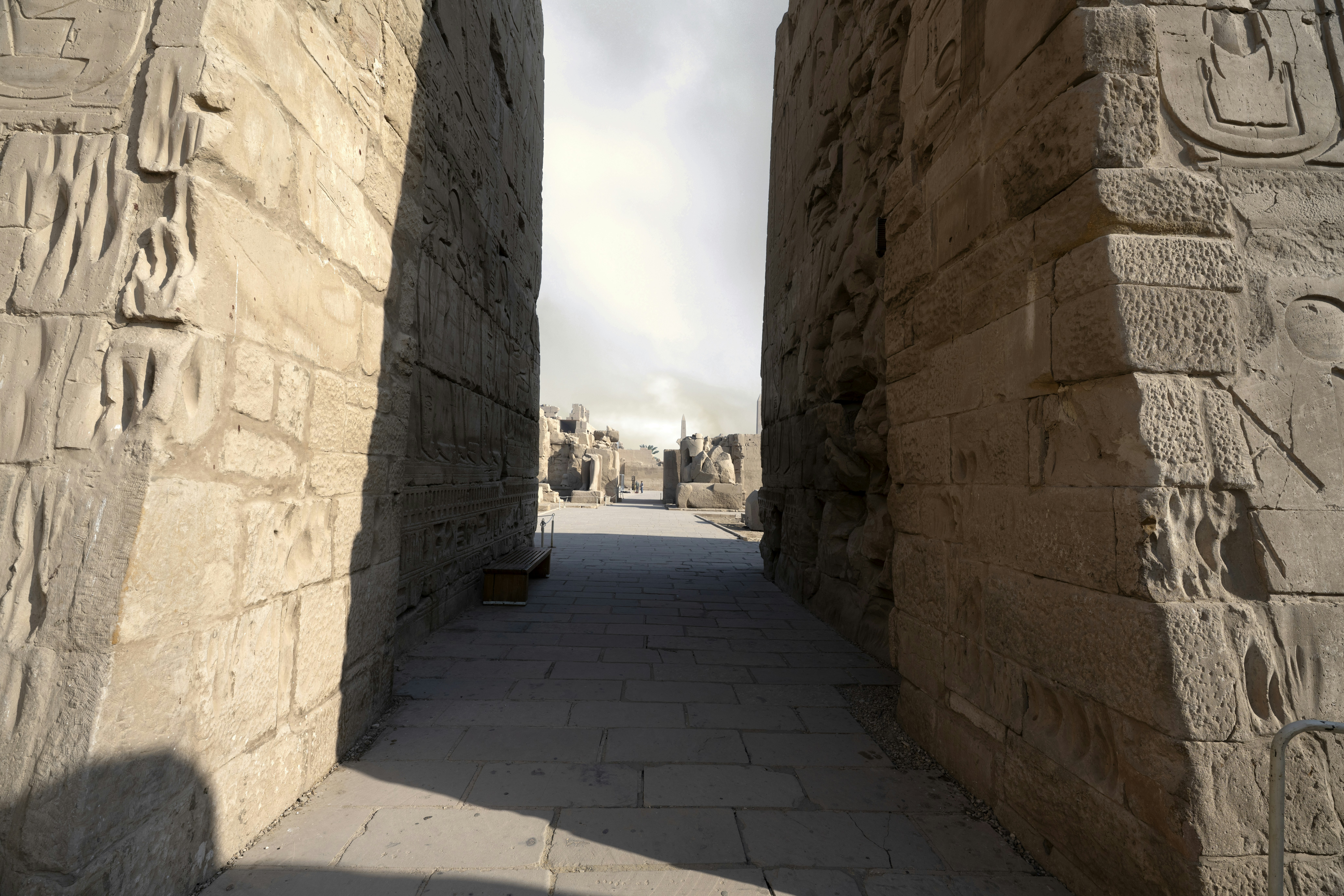 Gateway Through Stone Corridors: An Ancient Passage Framed by Sunlit Walls