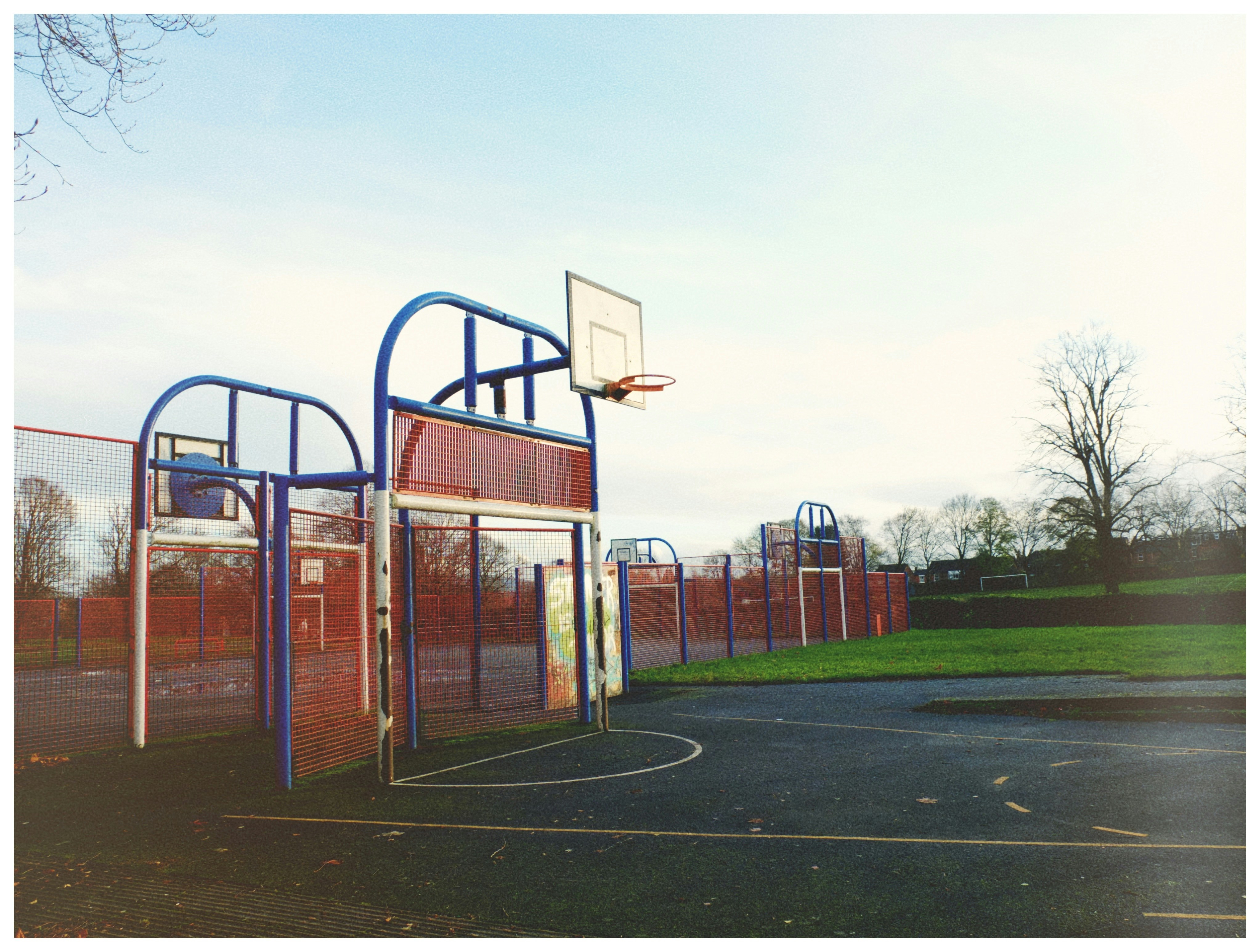 Outdoor basketball court with goals and soccer goals.