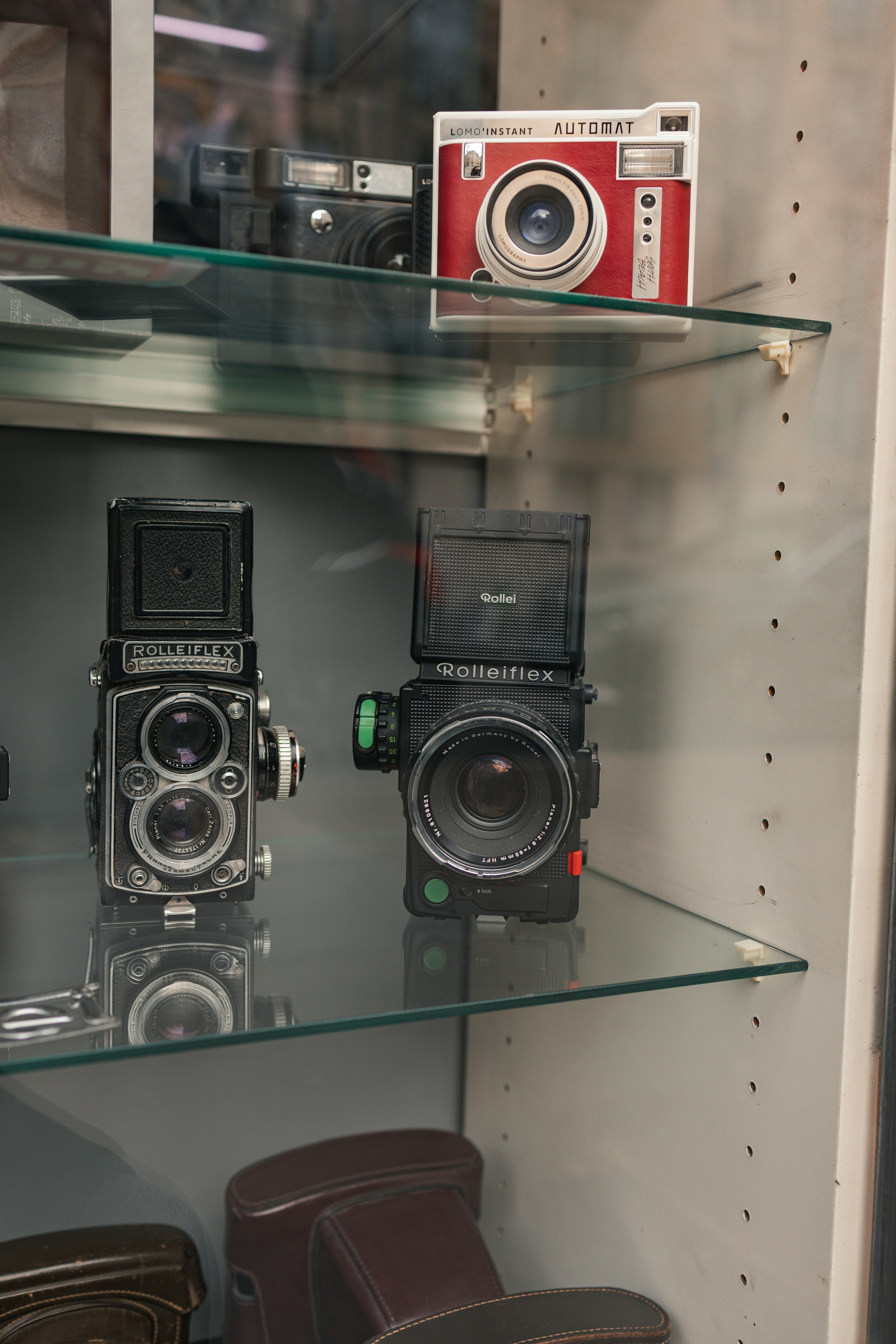 Vintage Voigtlander: A Display of Classic Cameras on Glass Shelves