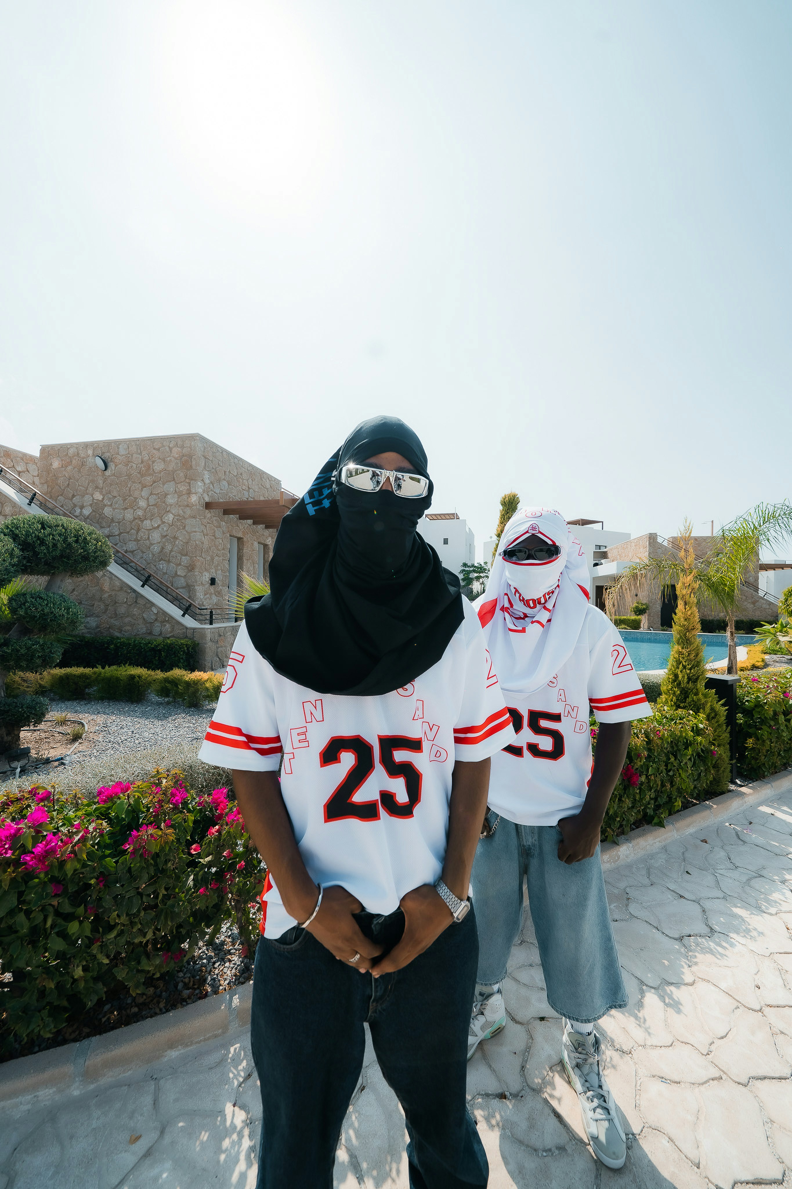 Streetwear energy with bold jerseys, creative styling, and a bright outdoor backdrop.