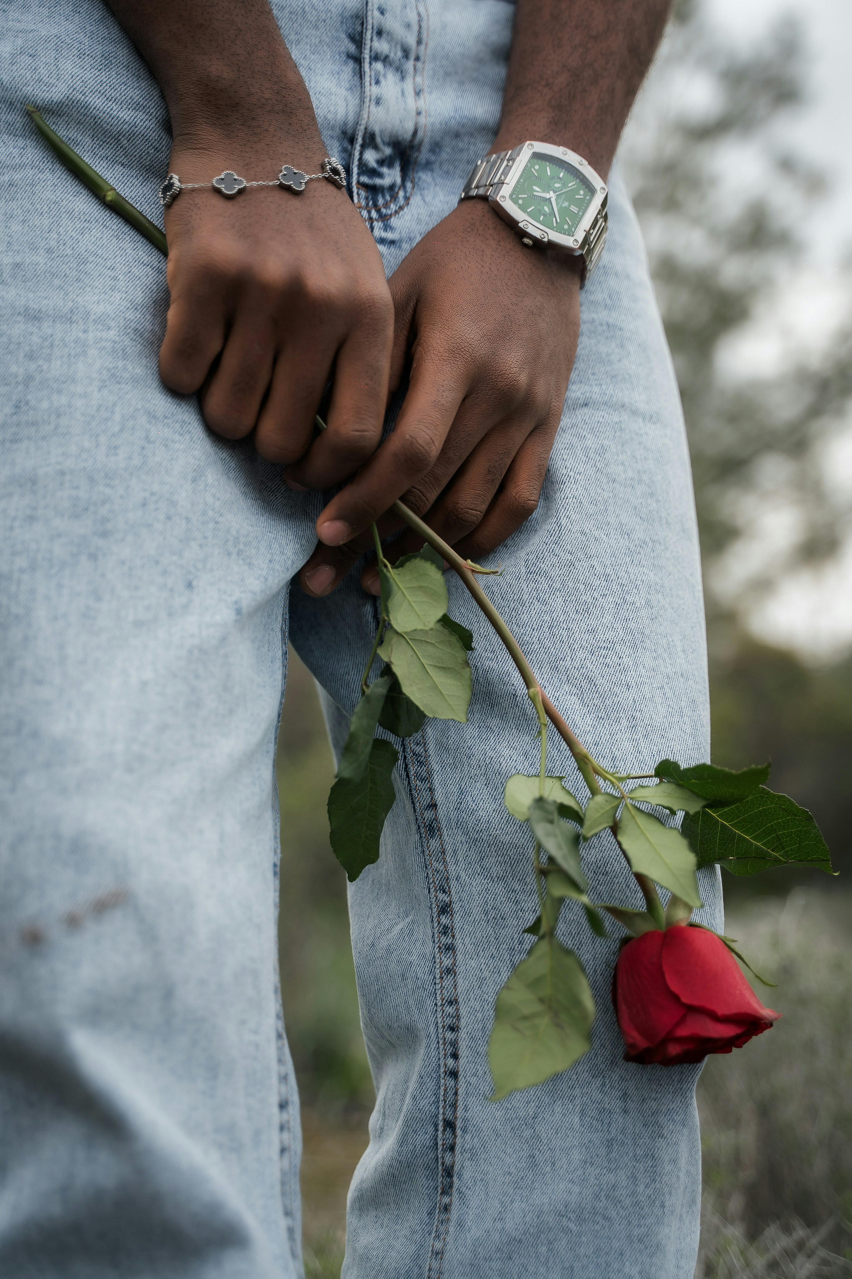 Red Rose Hues: Hands and Watch in Quiet Focus