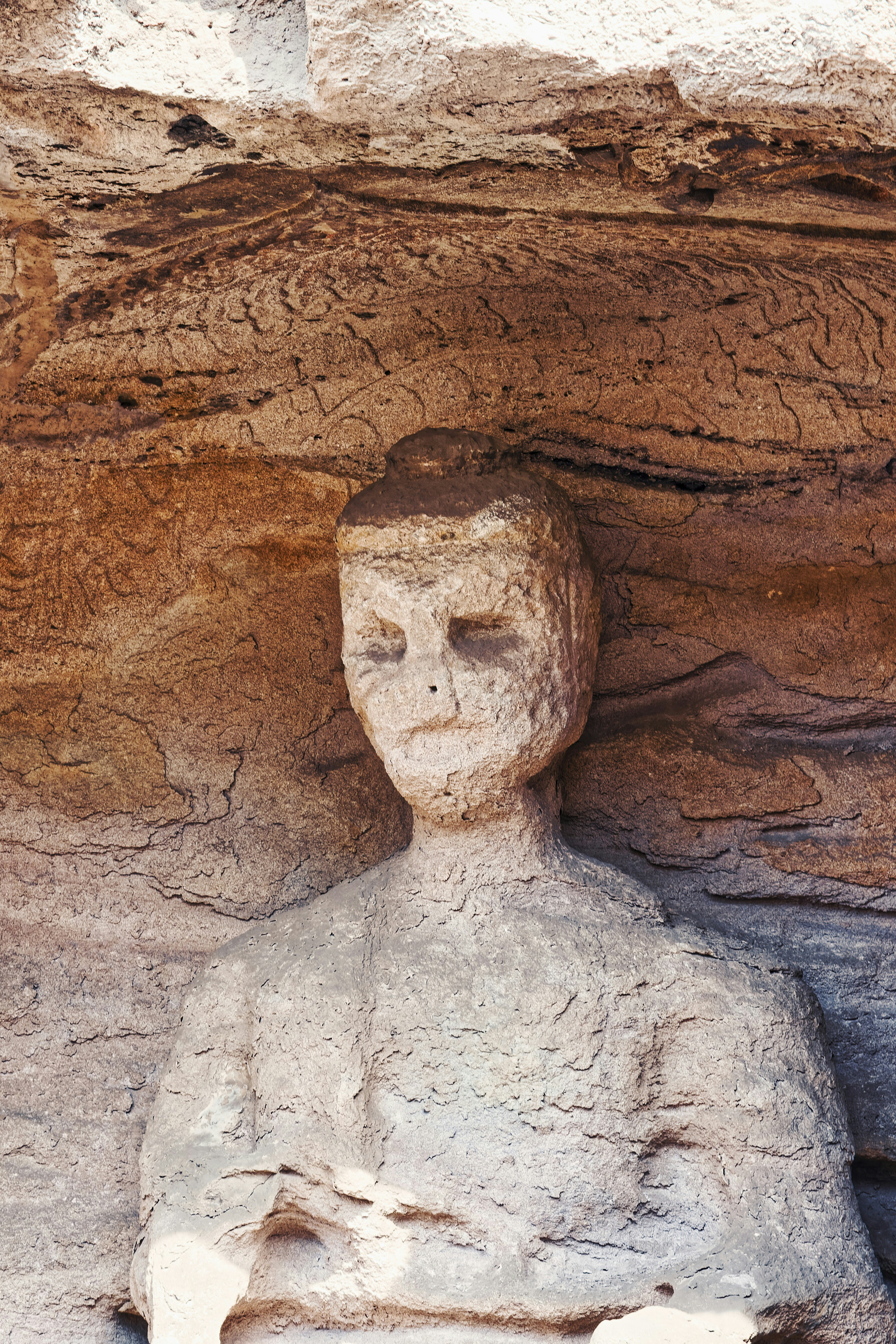 Ancient carved figure located at a historical site in a rocky landscape reflecting human artistry and craftsmanship - A weathered stone figure stands prominently in a rocky backdrop, showcasing intricate carvings. This artwork highlights ancient techniques from a long-lost civilization, surviving through time.