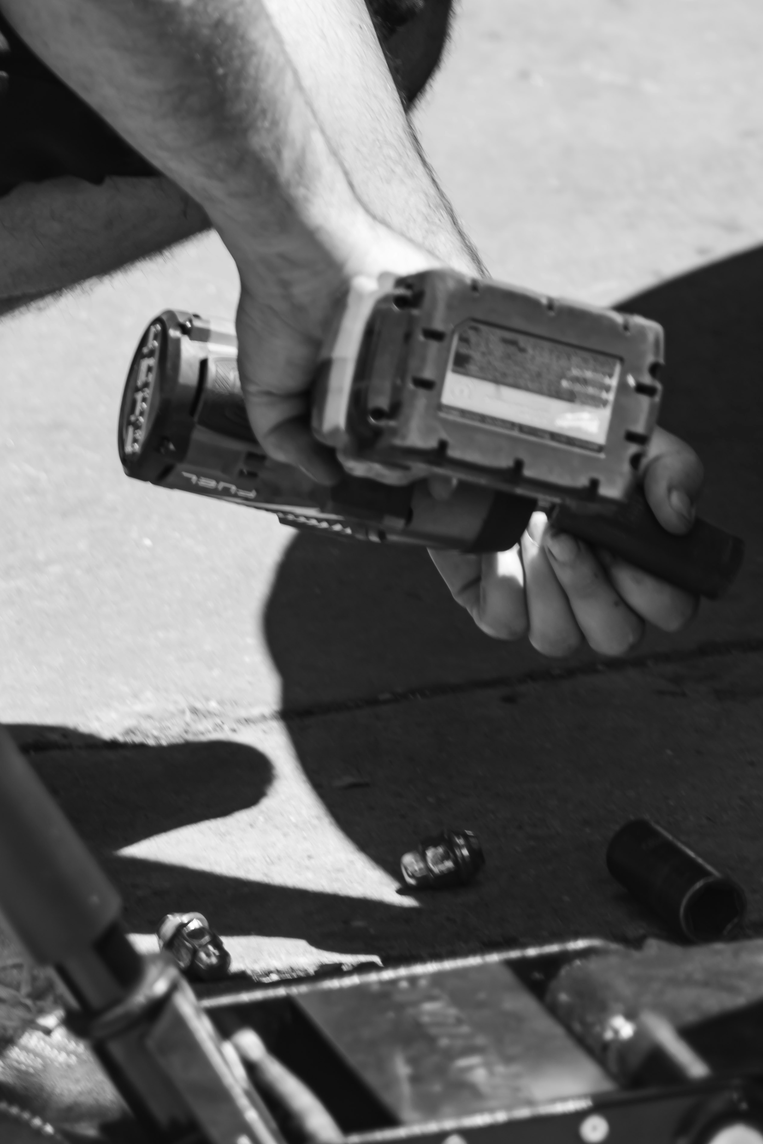 Hands-On Calibration: A Technician Aligns a Power Tool in the Sunlit Moment