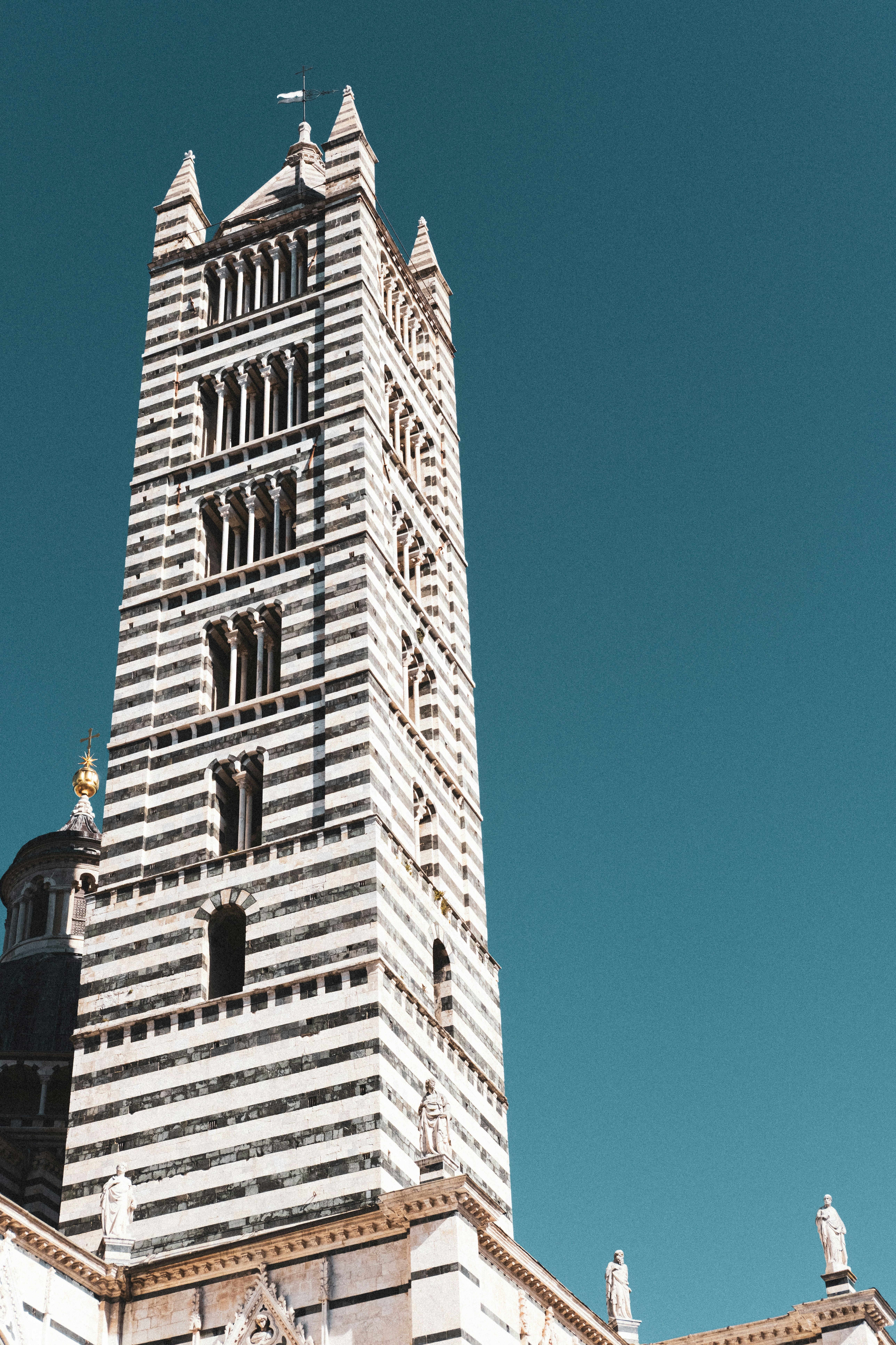 Striped Bell-Tower Rising Against a Clear Sky