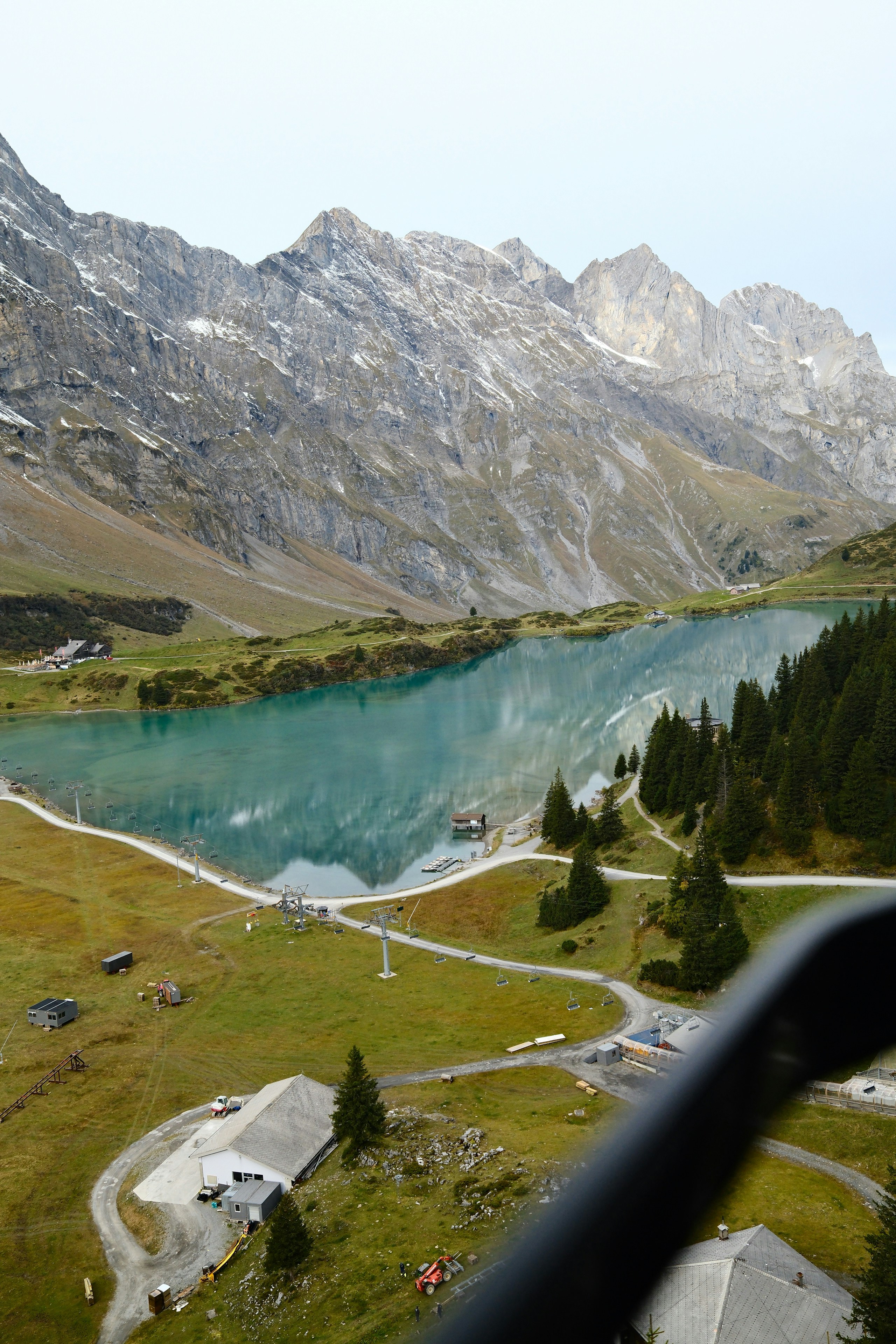 Turquoise Mirror: Alpine Lake Nestled Between Snowy Peaks