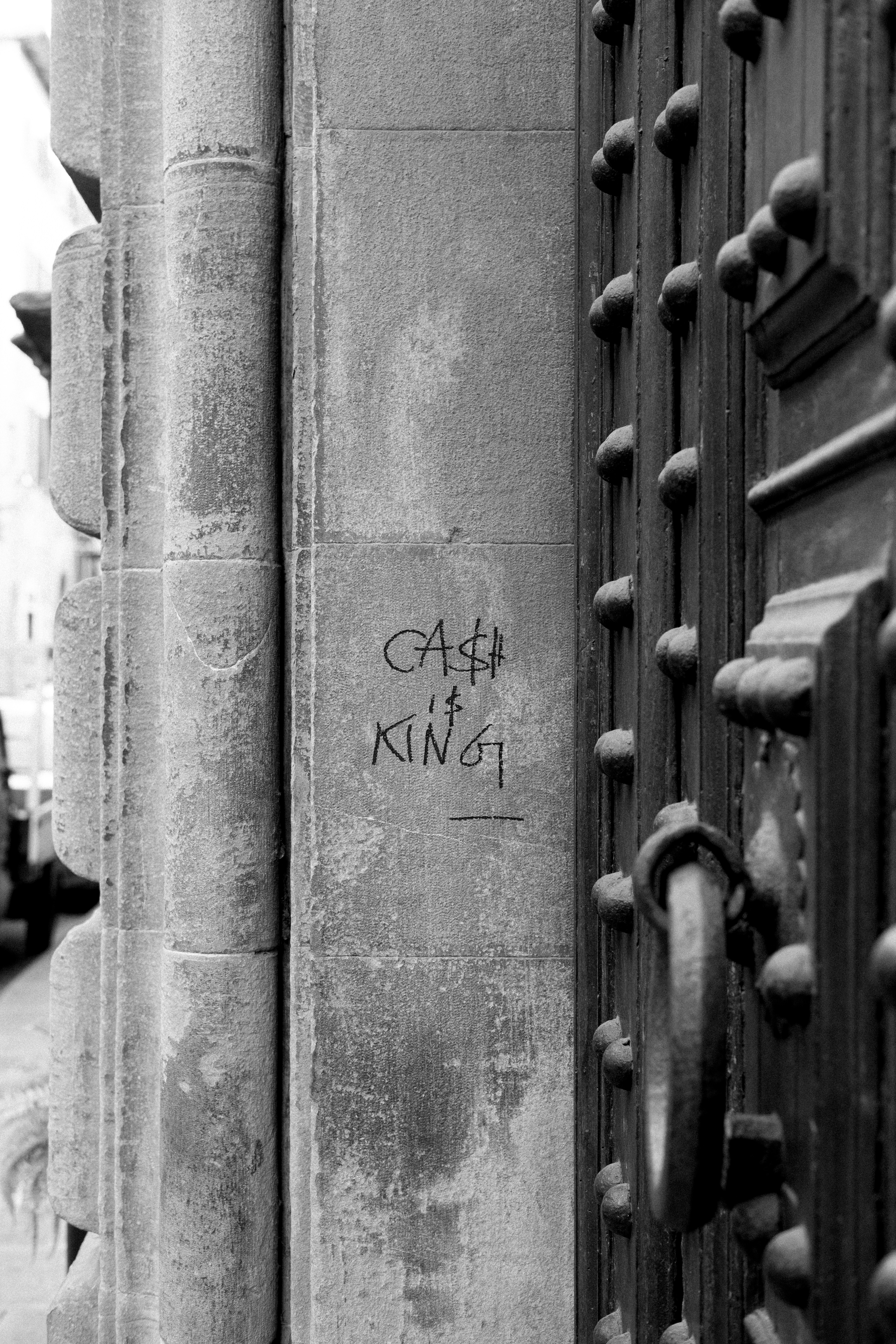 Graffiti on a Stone Column: Cash Is King