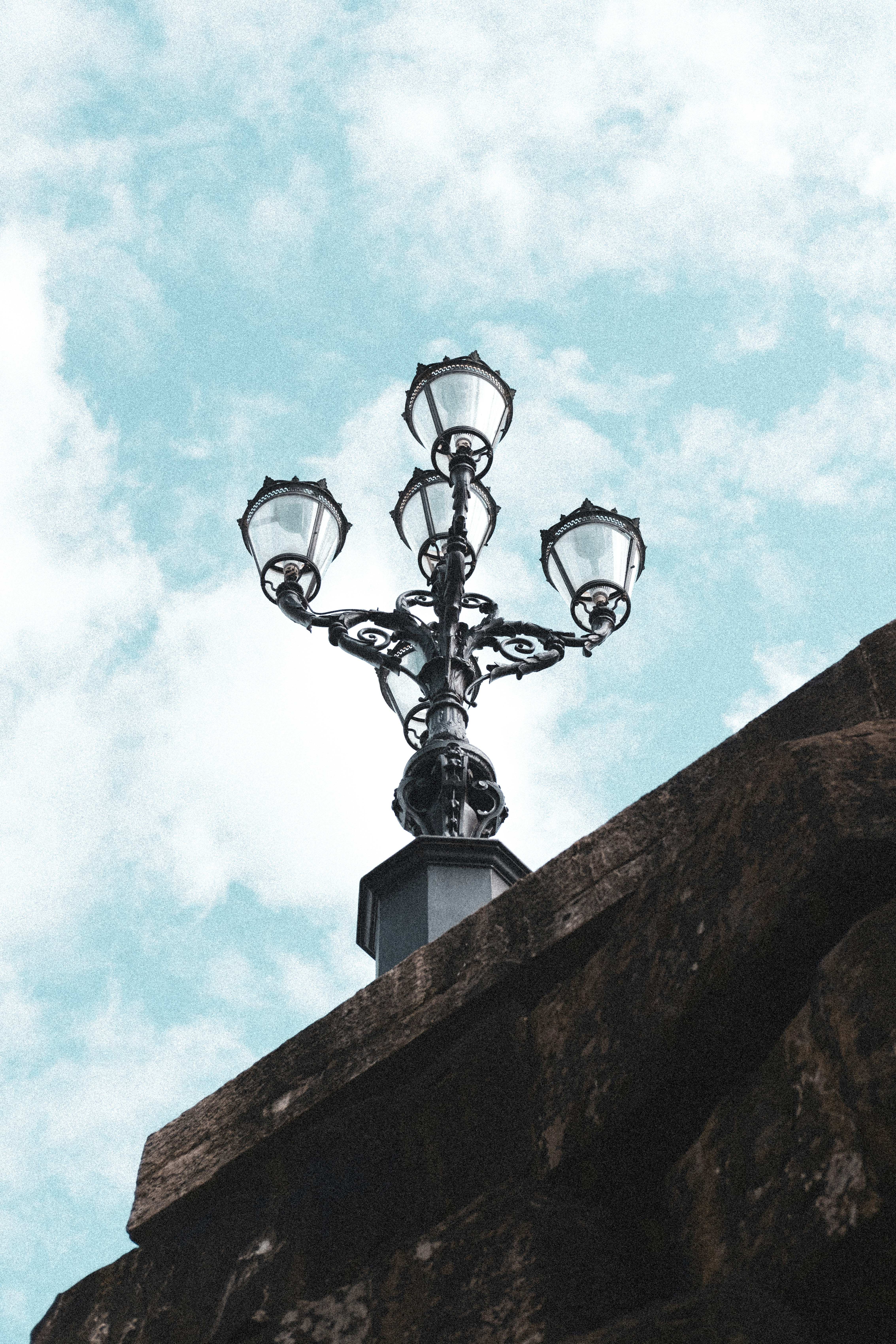 Luminary at the Edge: A Vintage Streetlamp Rising from the Wall