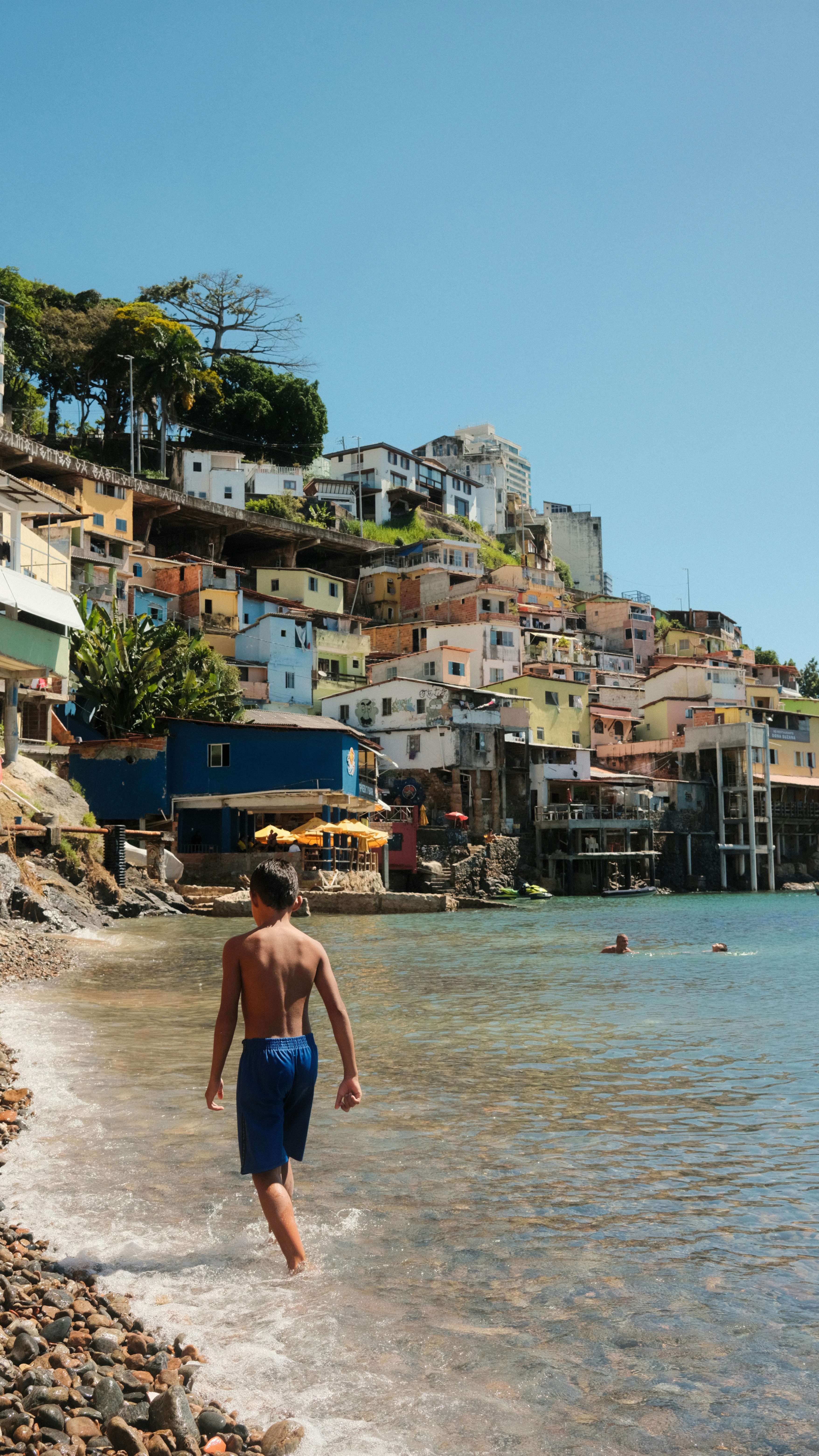 Terraced coastal village wakes to a sunlit shoreline
