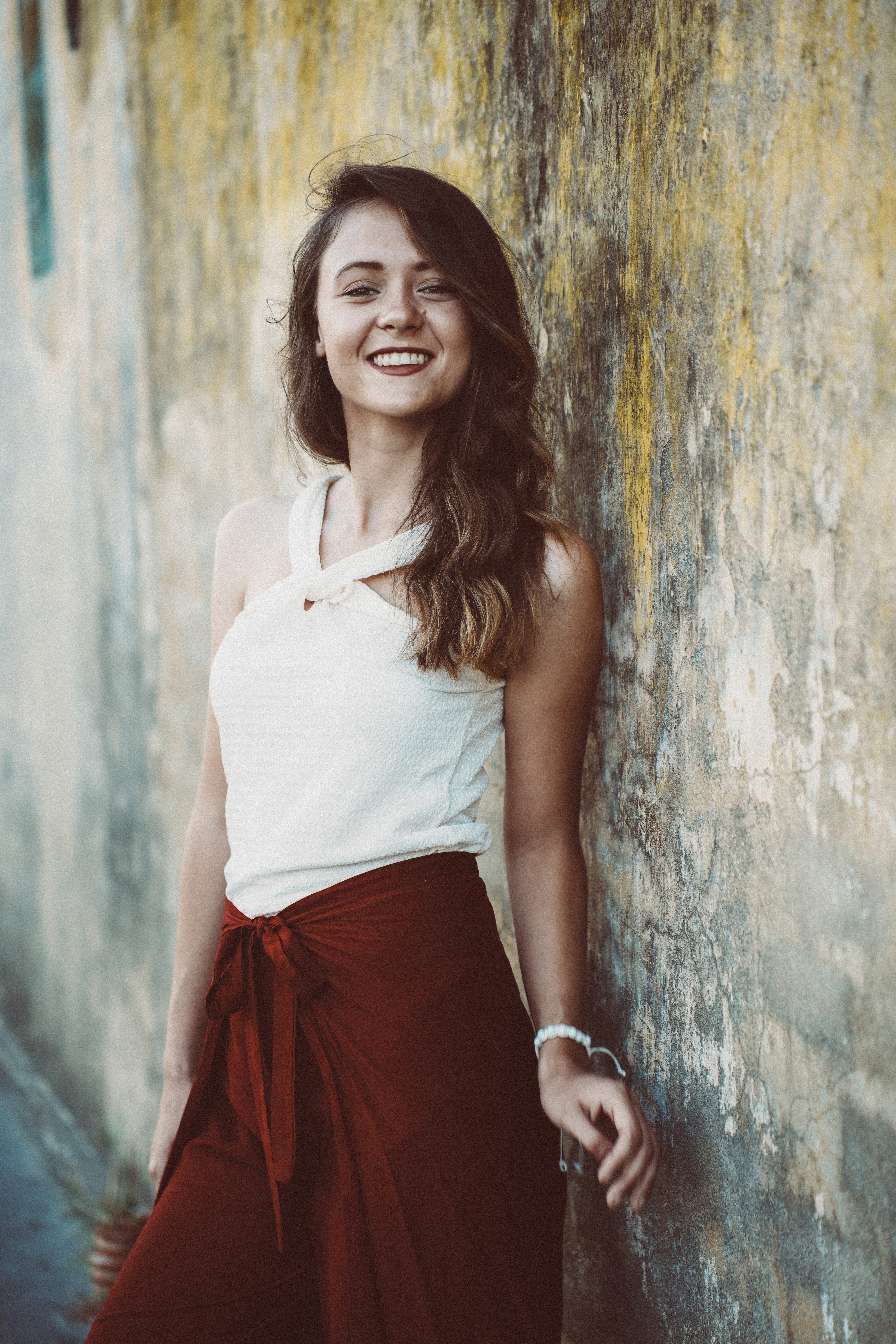 Sunlit Portrait Against Weathered Wall