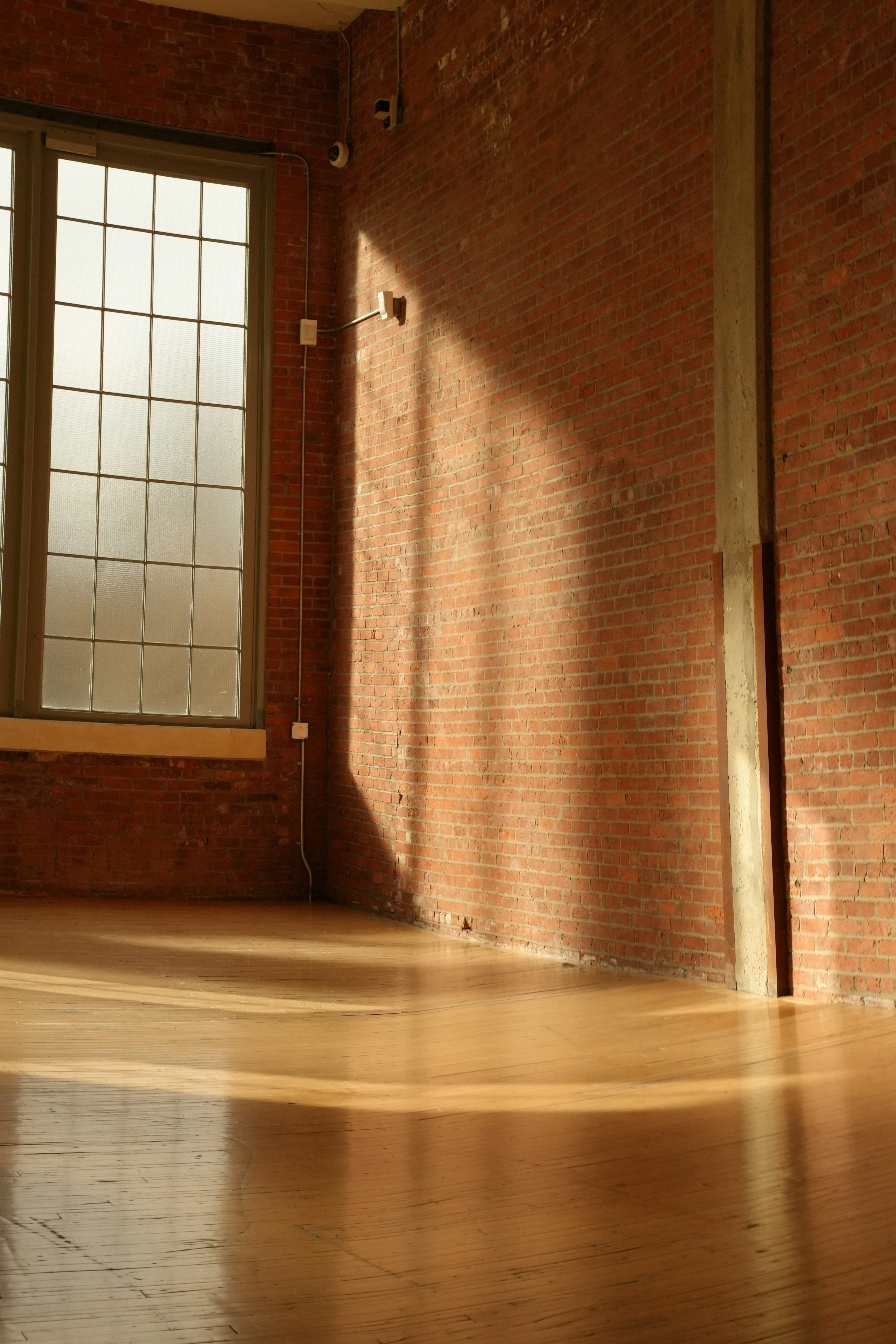 Sunlit Corner of a Brick Studio