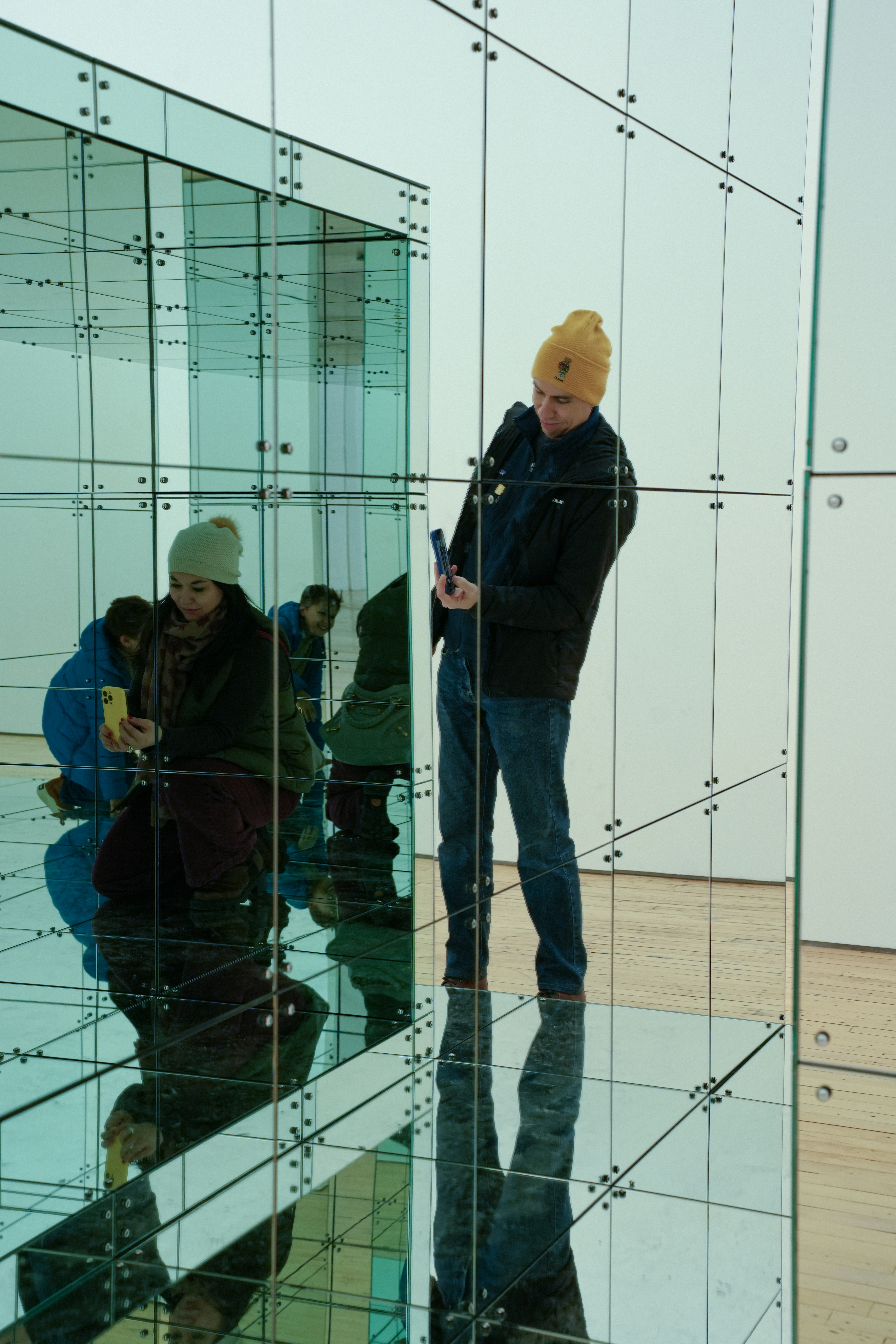 Reflections in a Glass Cube: A Man Deliberates in a Mirrored Gallery