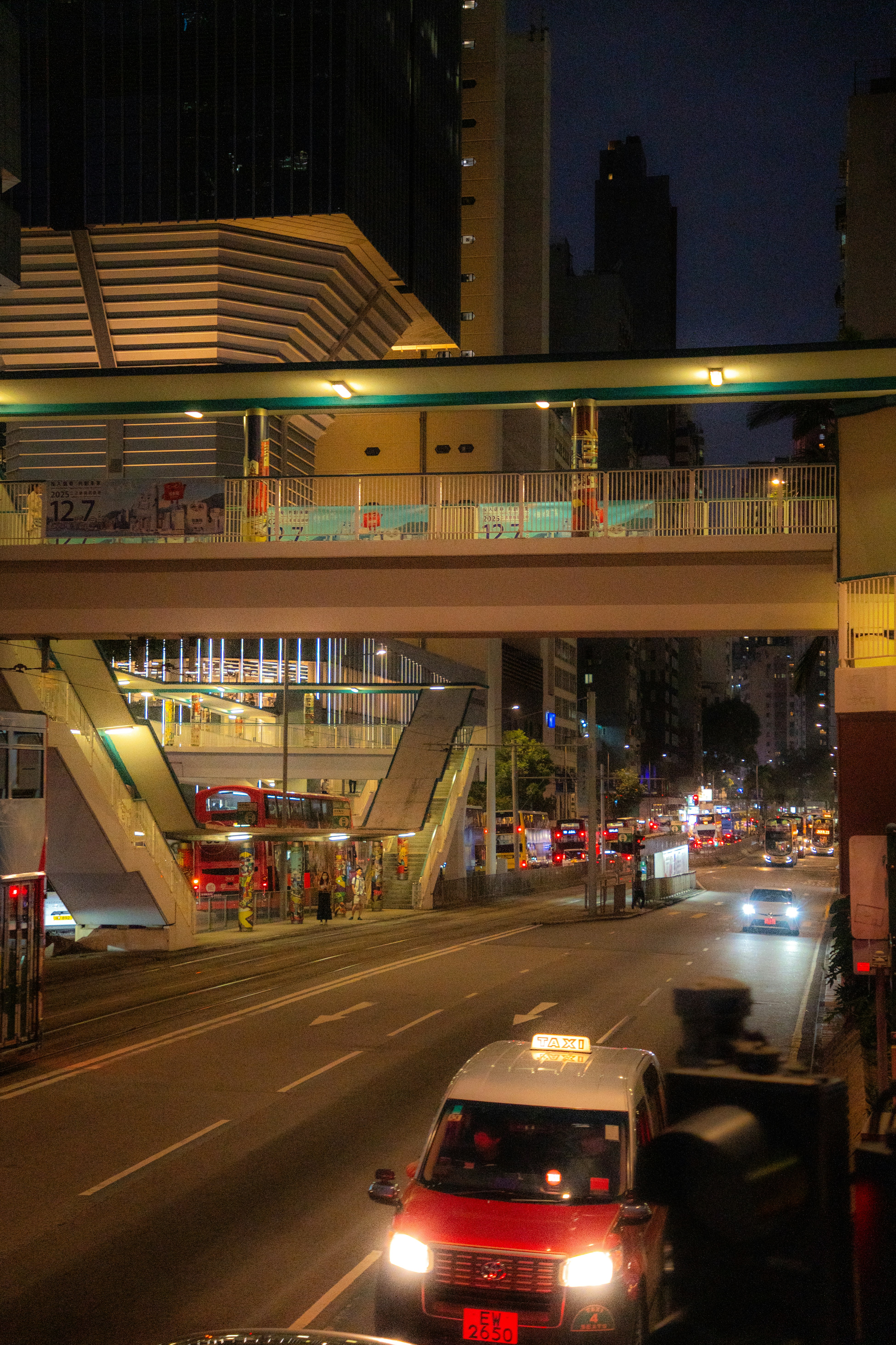 Night City Street: A Red-Top Taxi Under Neon Bridges